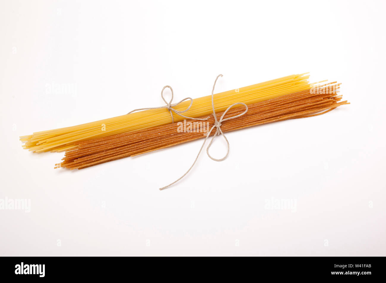 bundle of spaghetti on a white background Stock Photo - Alamy