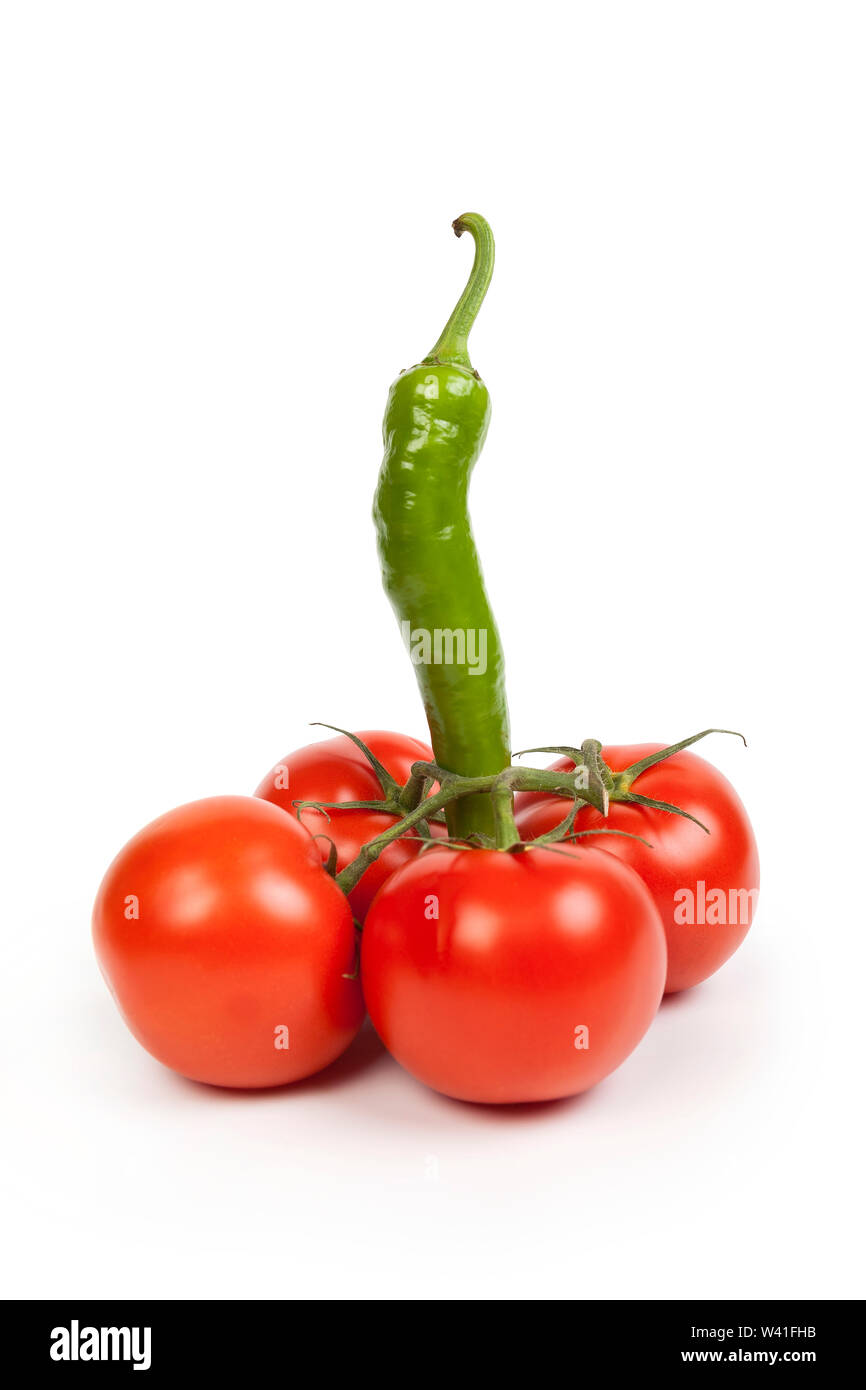 Composition of tomatoes on the vine and Fefferoni, green Mediterranean ...