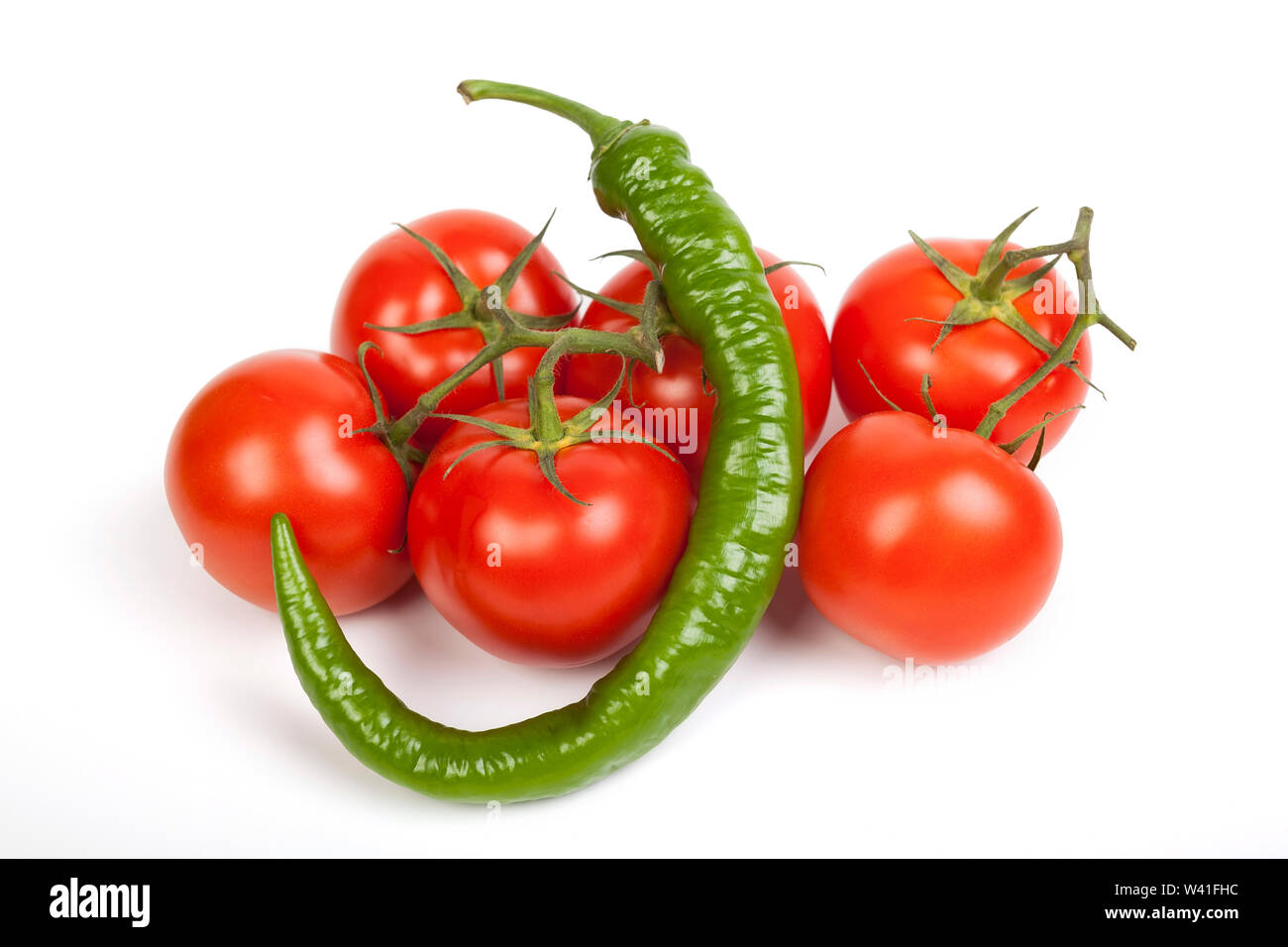 Tomatoes on the vine and Fefferoni, green Meditteranean semi-hot pepper ...