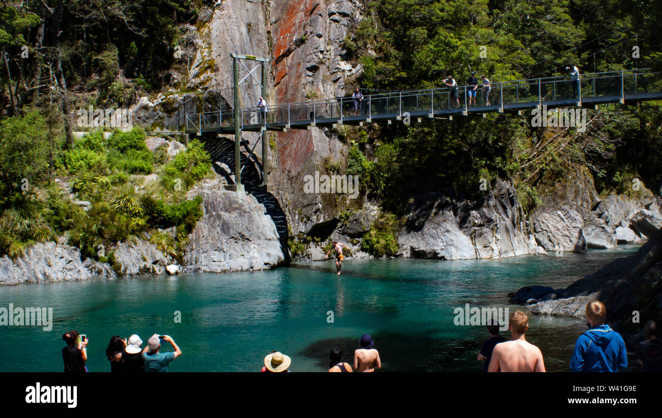 Jumping from the bridge at the Blue Pools in Wanaka, New Zealand Stock ...