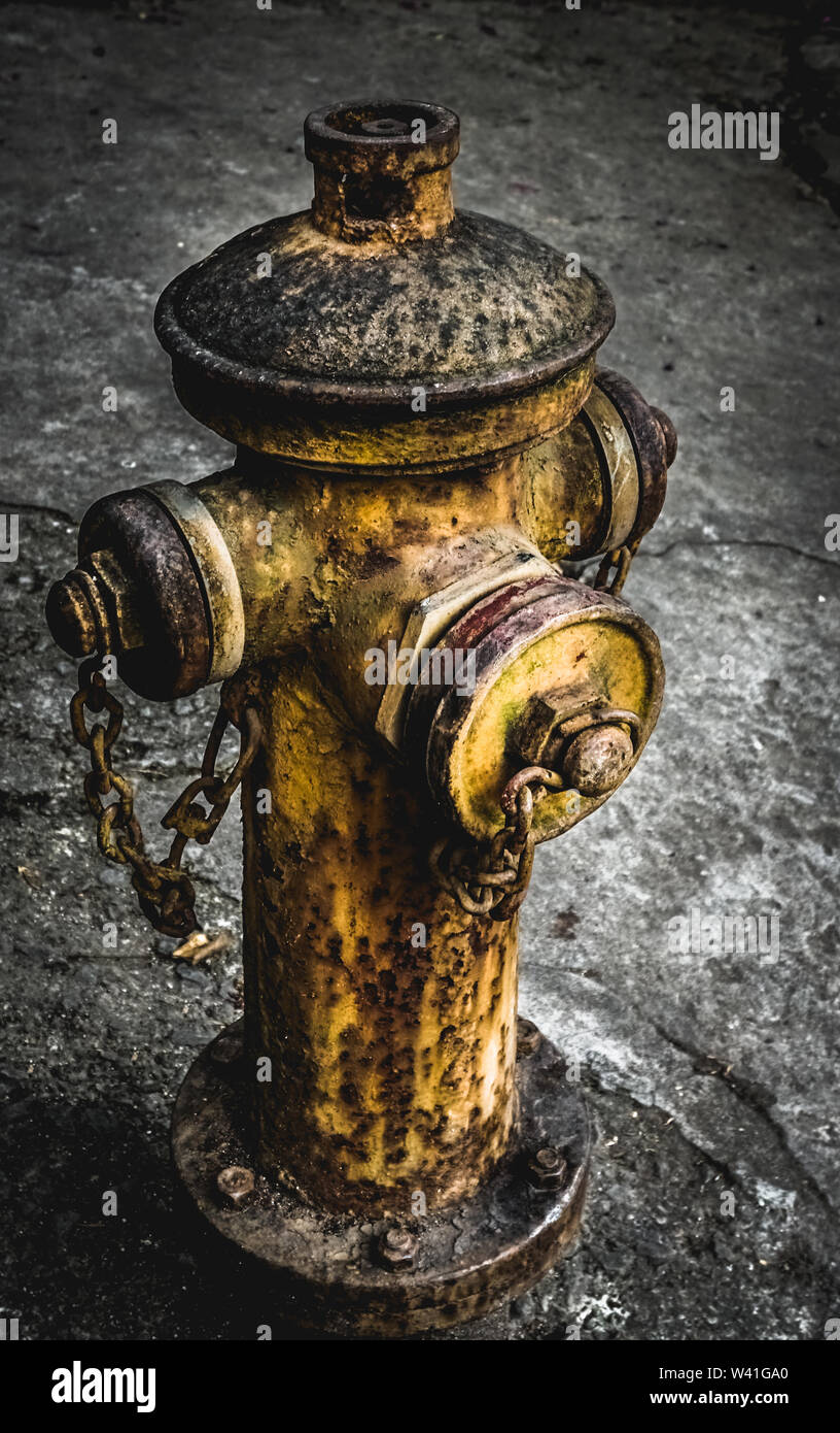 Yellow rusty antique fire hydrant in a run down factory Stock Photo - Alamy