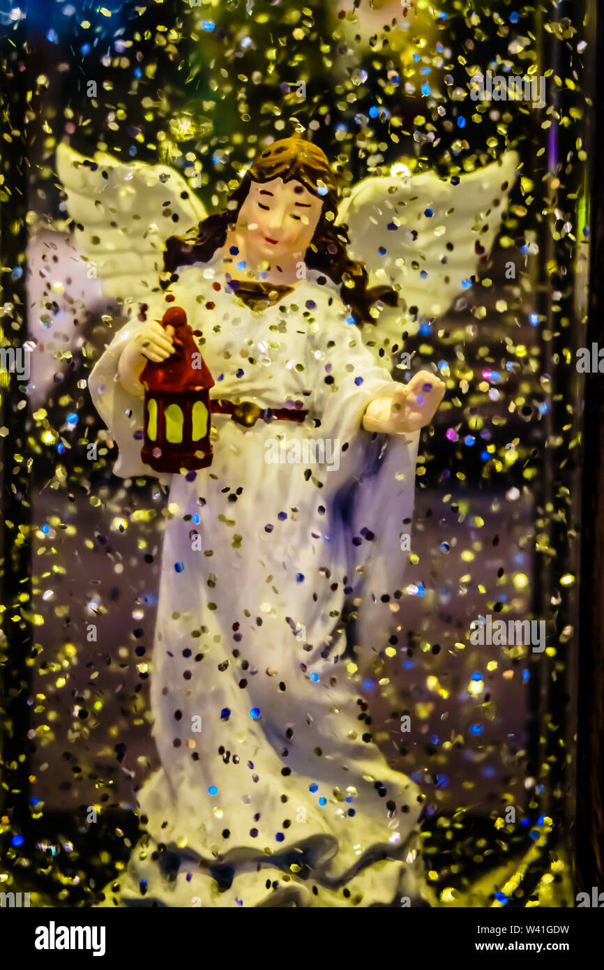 Christmas Angel with glitter floating around her Stock Photo - Alamy