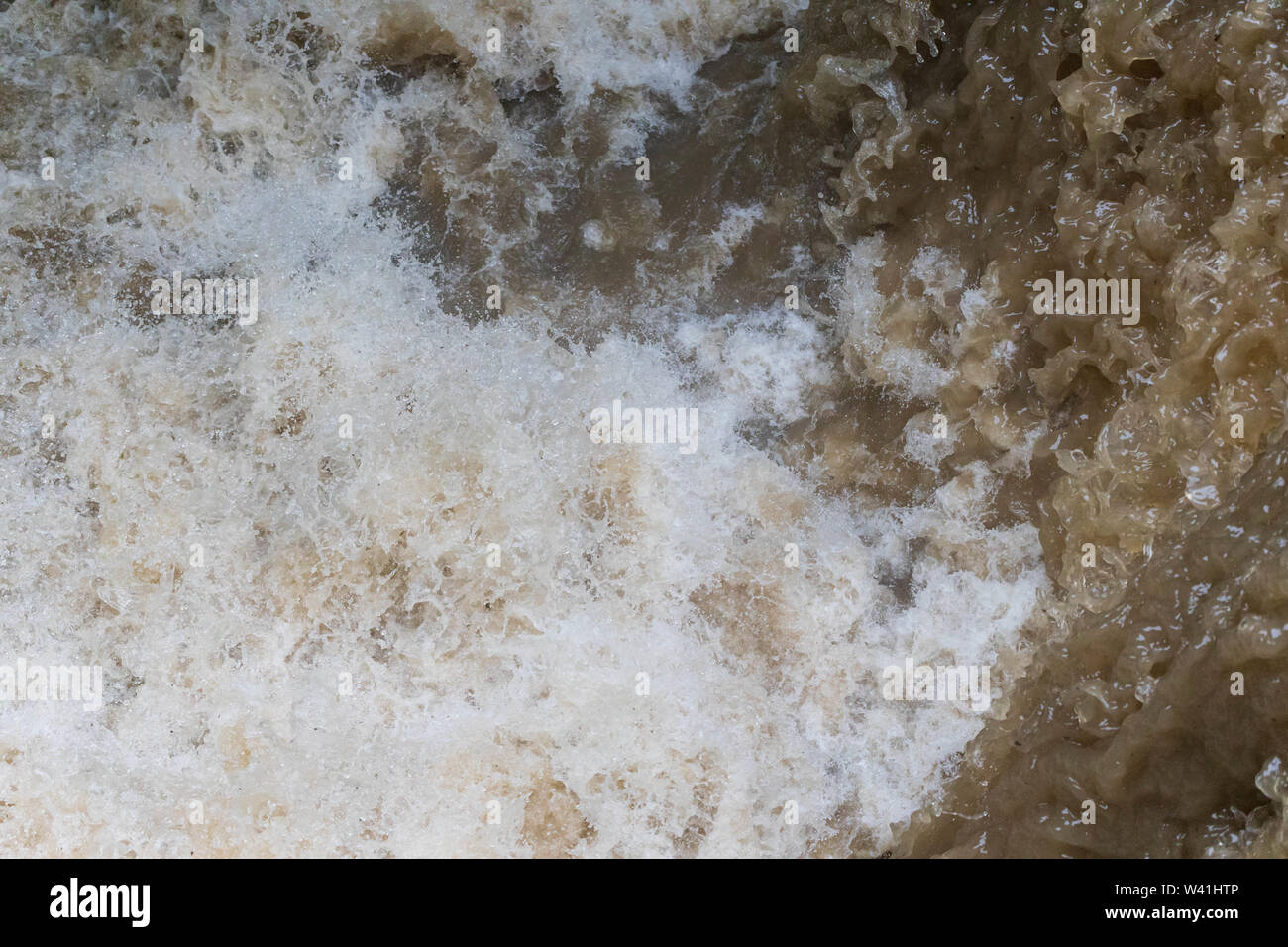 Overhead view of fast flowing brown water in flooding event Stock Photo ...