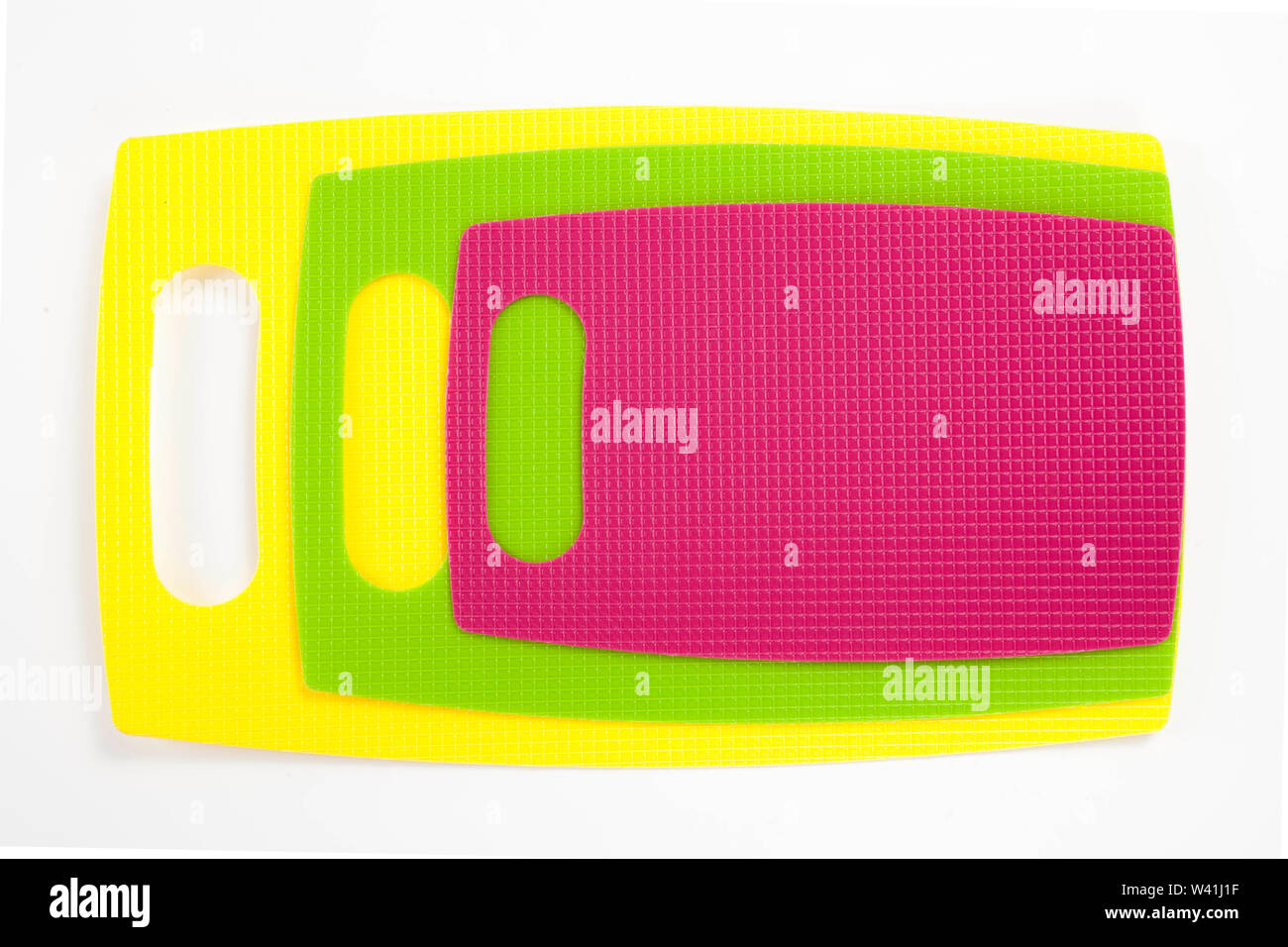 Kitchen set of plastic cutting boards in different colors and sizes ...