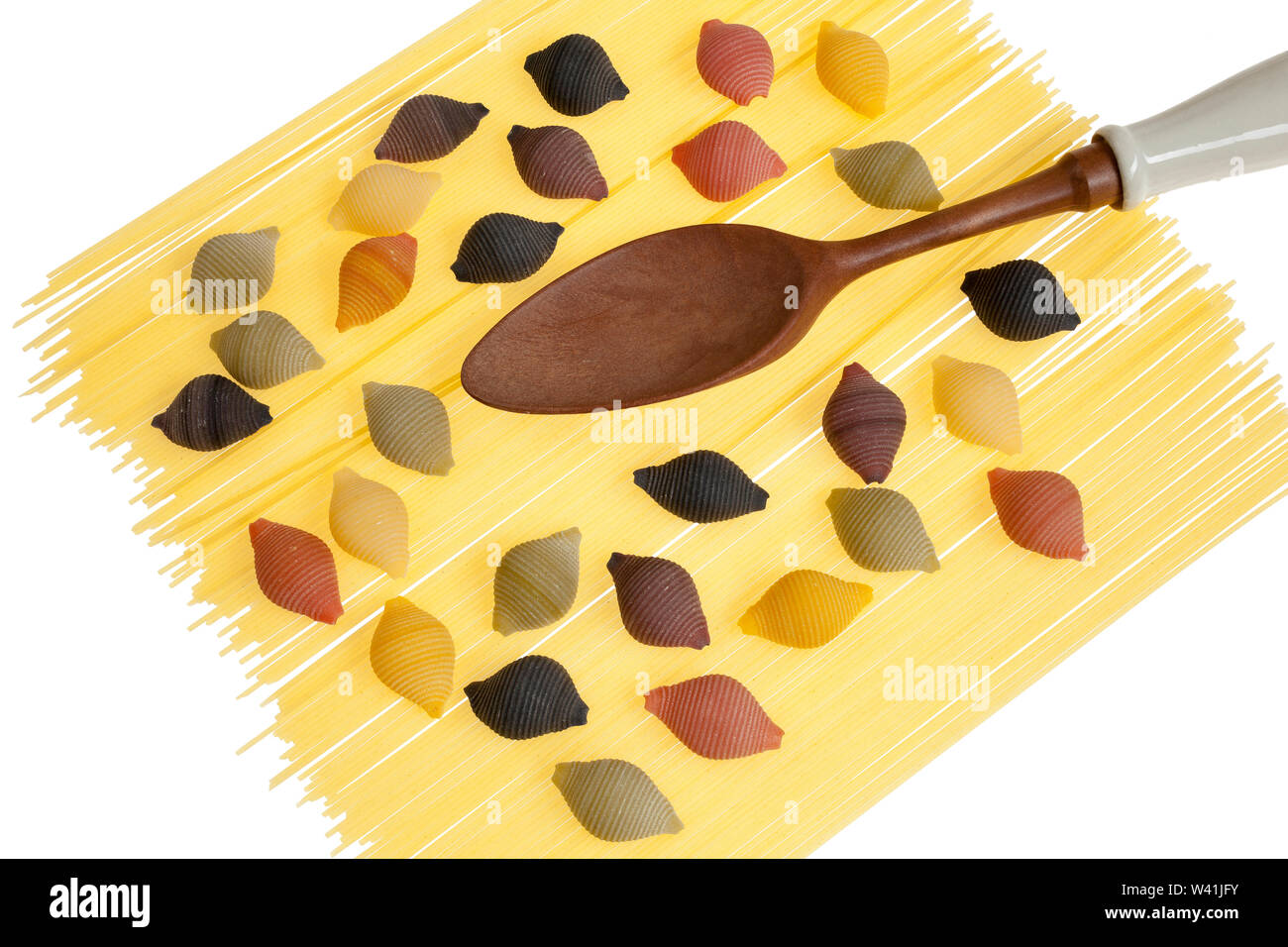Five color shell pasta over spaghetti and wooden spoon, isolated on ...