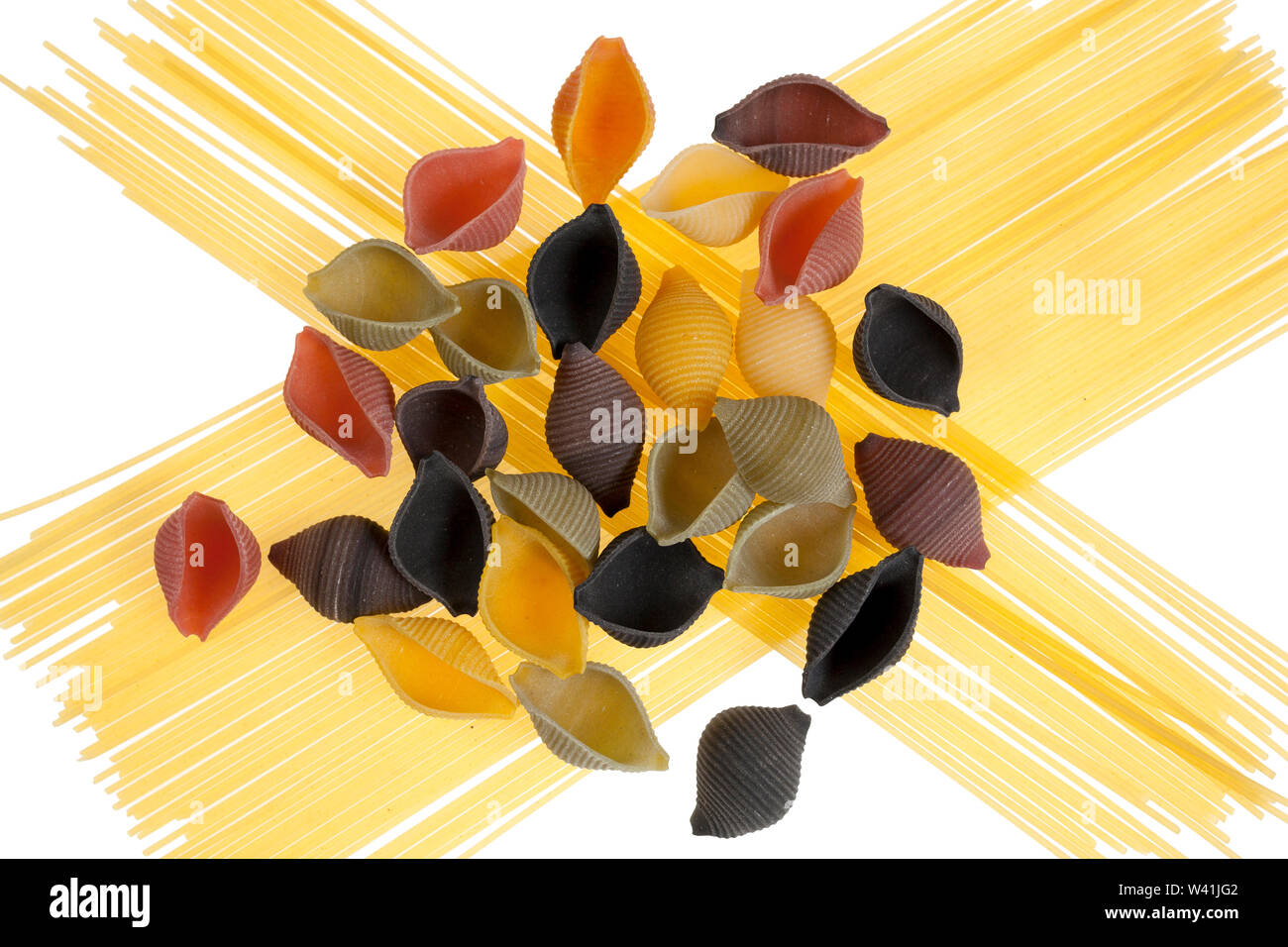 Five color shell pasta over spaghetti, isolated on white background ...