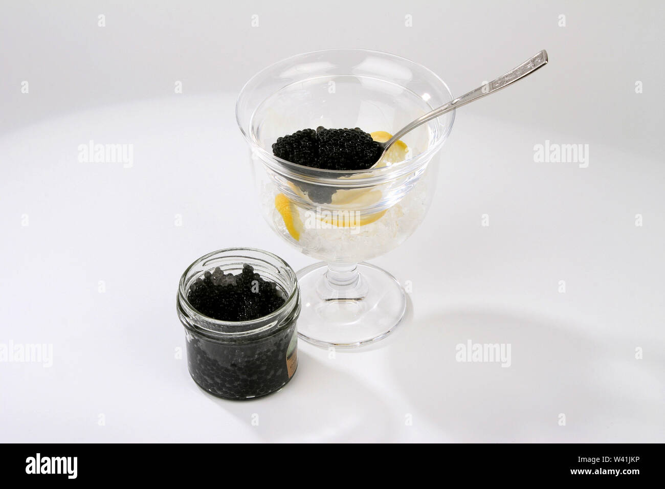 Caviar with spoon and lemon isolated on white Stock Photo - Alamy