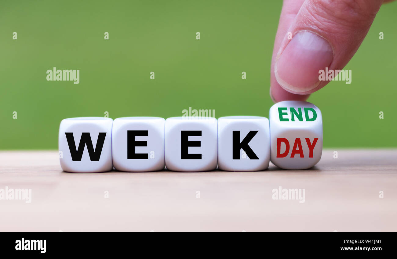 Hand turns a dice and changes the word "weekday" to "weekend Stock ...