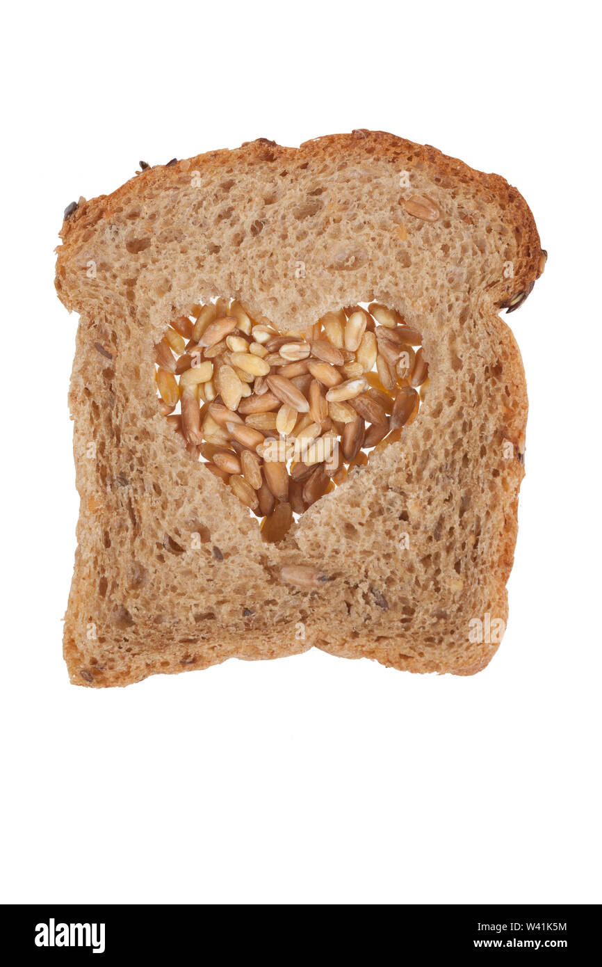 Slice of whole grain bread with cutted heart inside, filled with grains ...