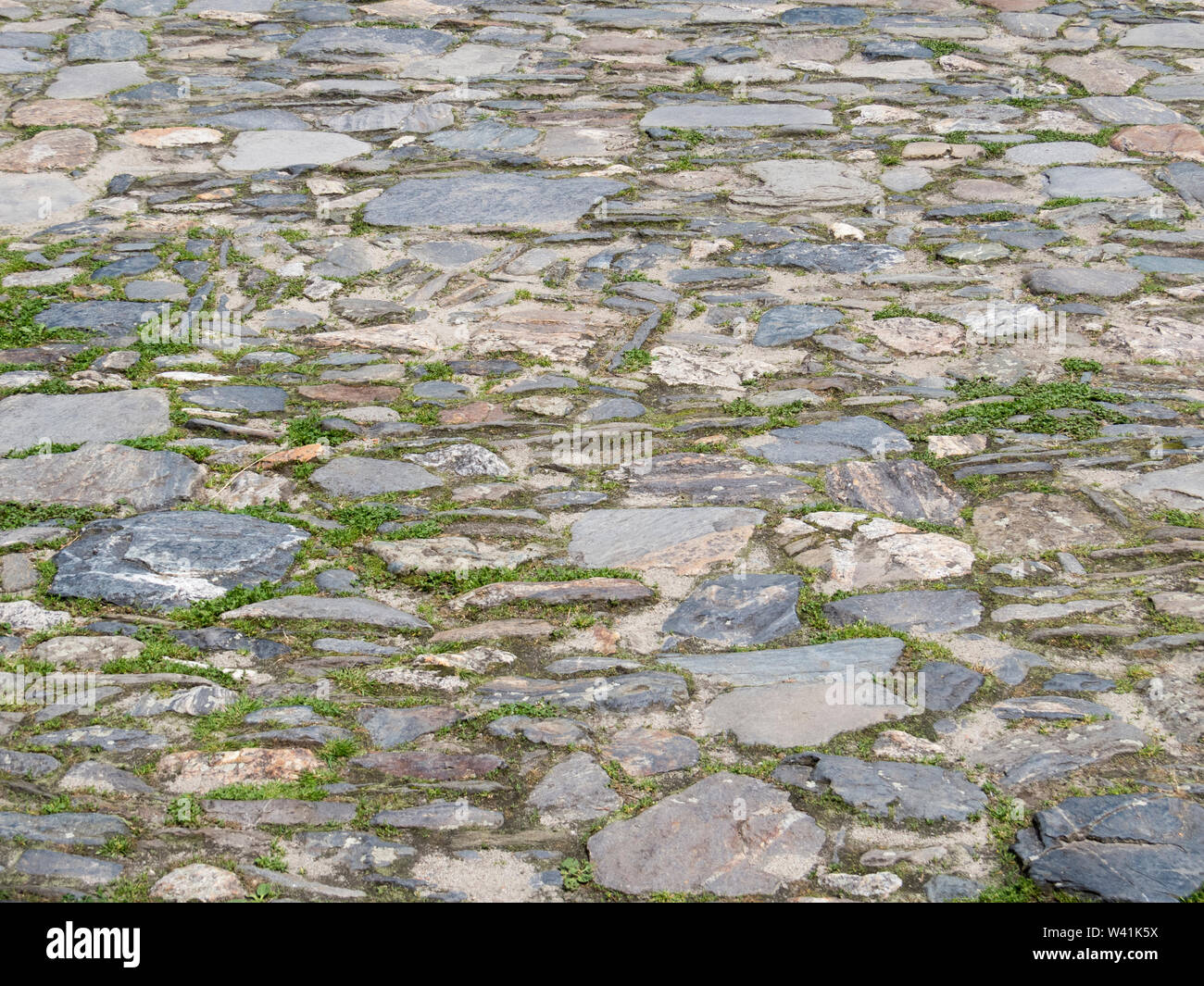 Stone pavement ground with grass Stock Photo - Alamy