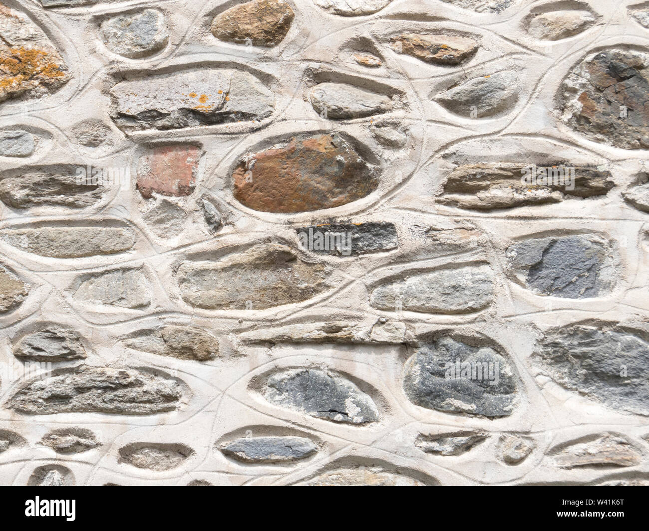 Stone wall with mortar and outlined shapes of the stones on the mortar ...