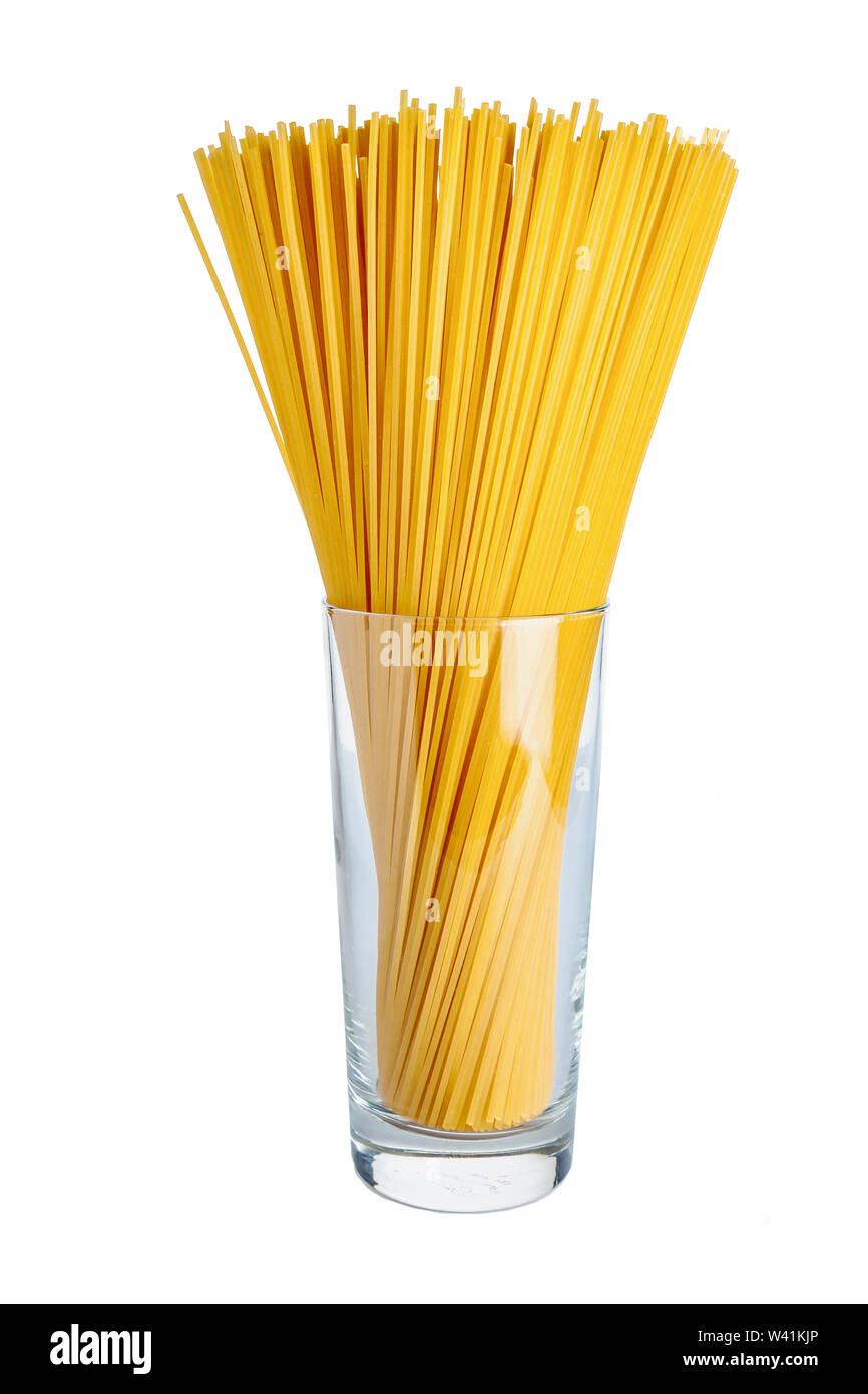 Spaghetti in a glass beaker, closeup on a white background. Isolate ...