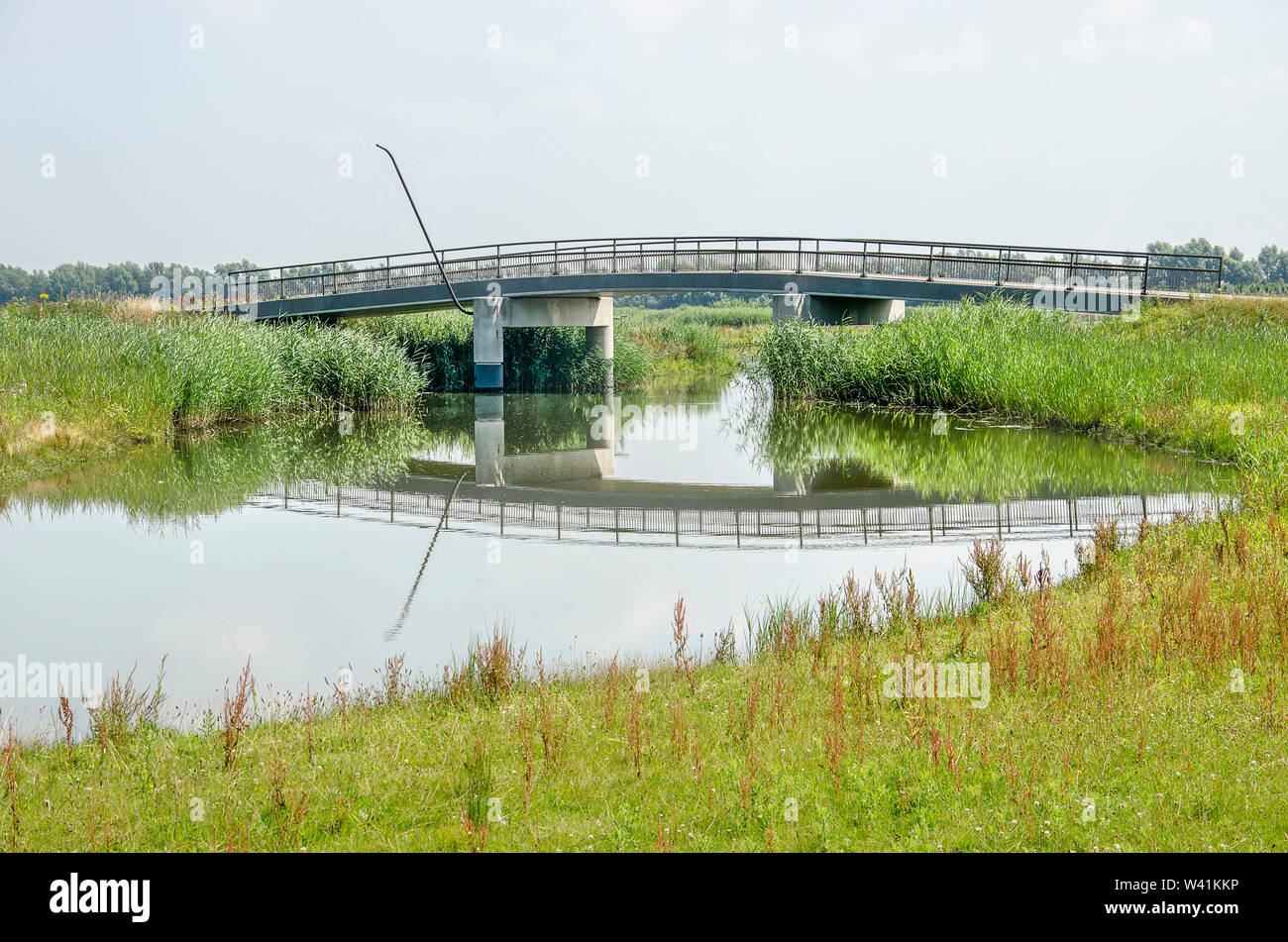 Concrete bridge for pedestrians and cyclists across a creek in the ...