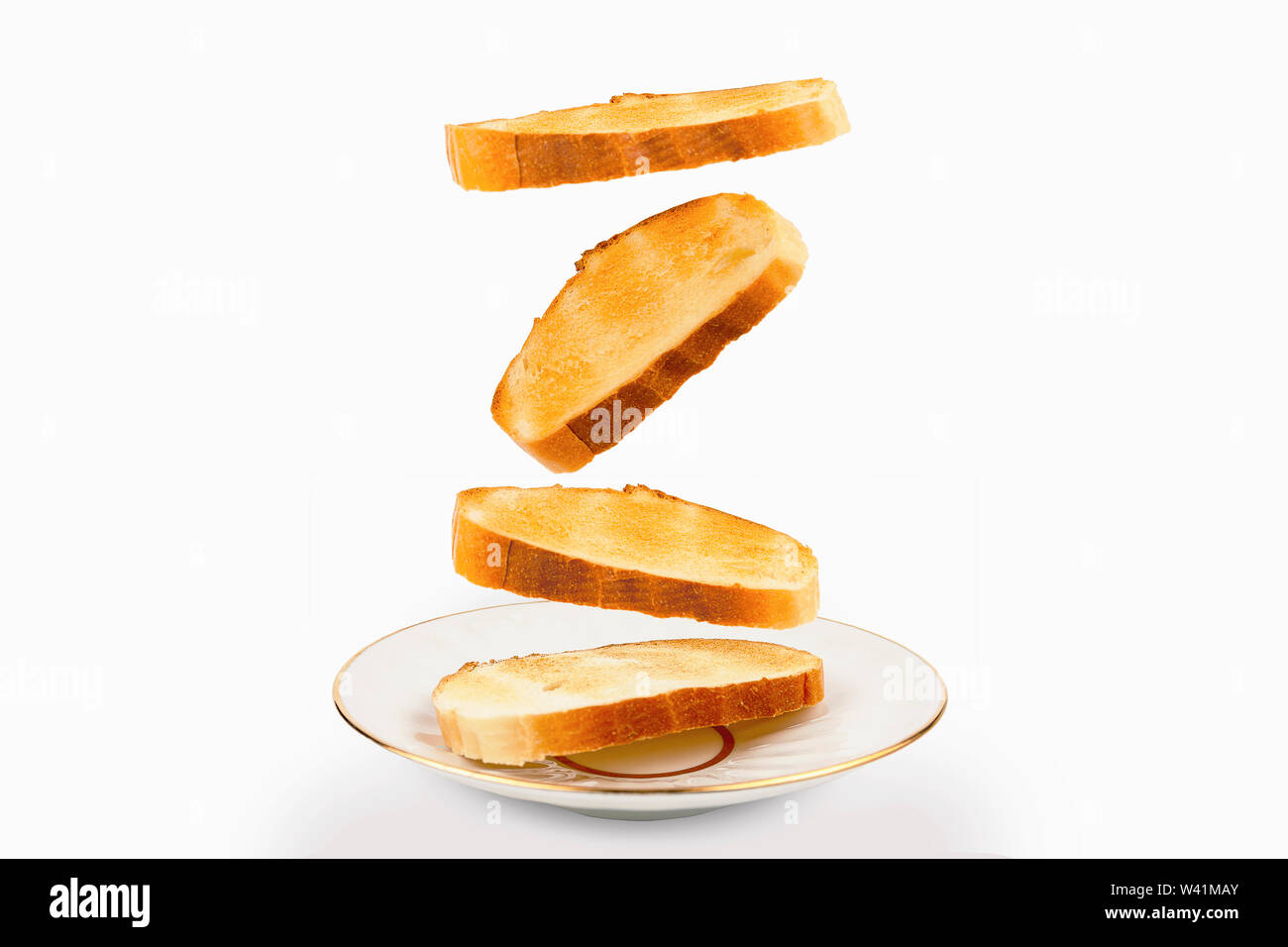 Toasts are falling on a saucer close-up on white background Stock Photo ...