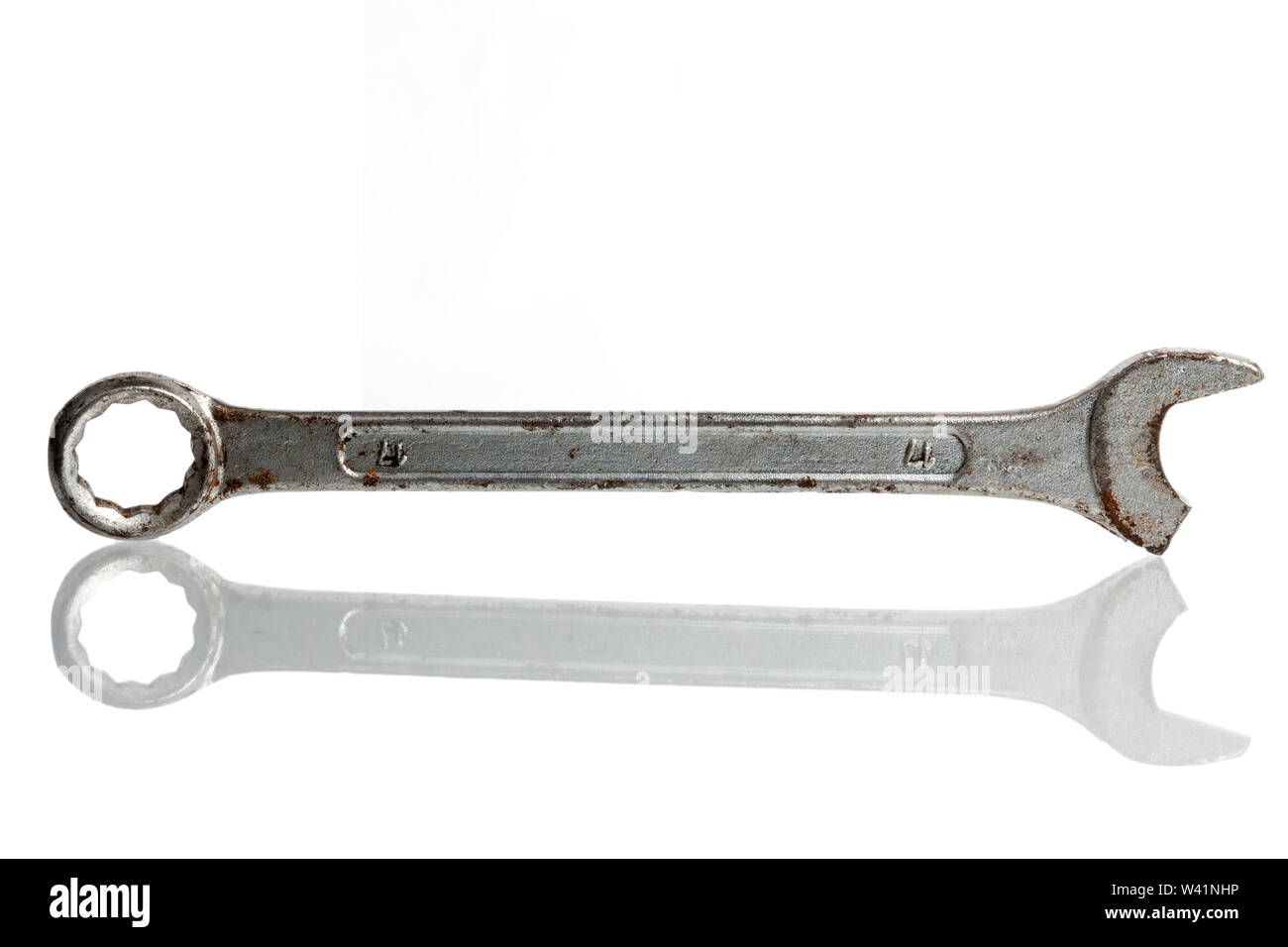 Old broken wrench on a white background with reflection Stock Photo - Alamy