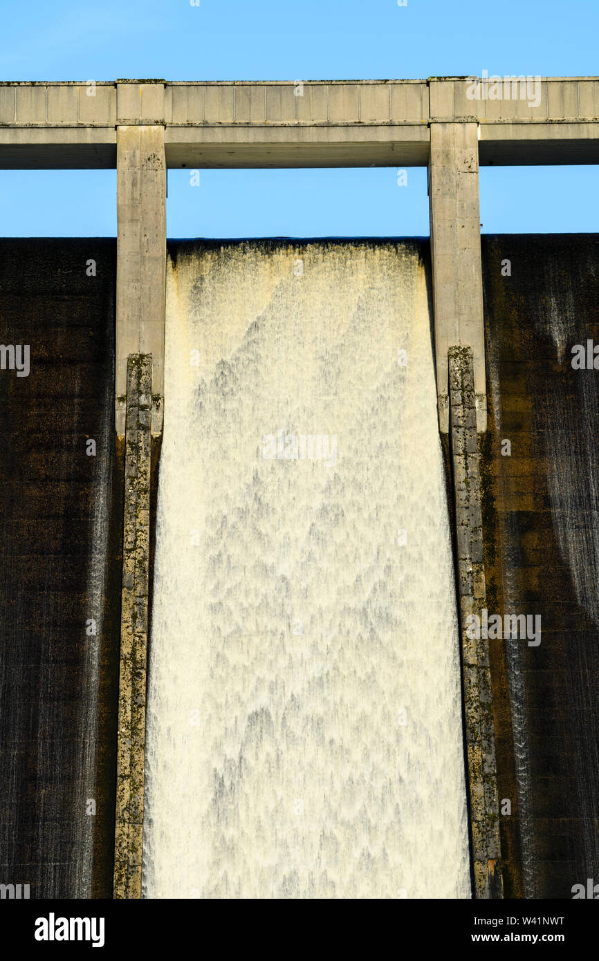 Water flowing over high, steep, concrete dam spillway at Thruscross ...