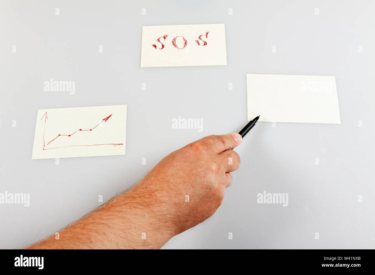 A hand holds a pen and shows on a blank sticker. Template Stock Photo ...