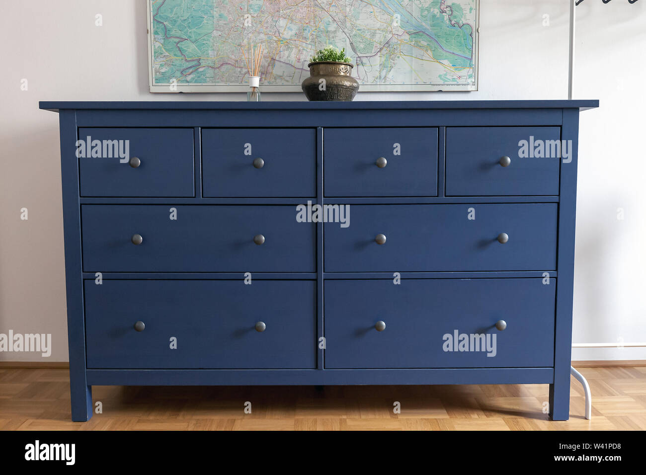 Blue dresser in room. Wooden furniture with vase in bedroom Stock Photo ...