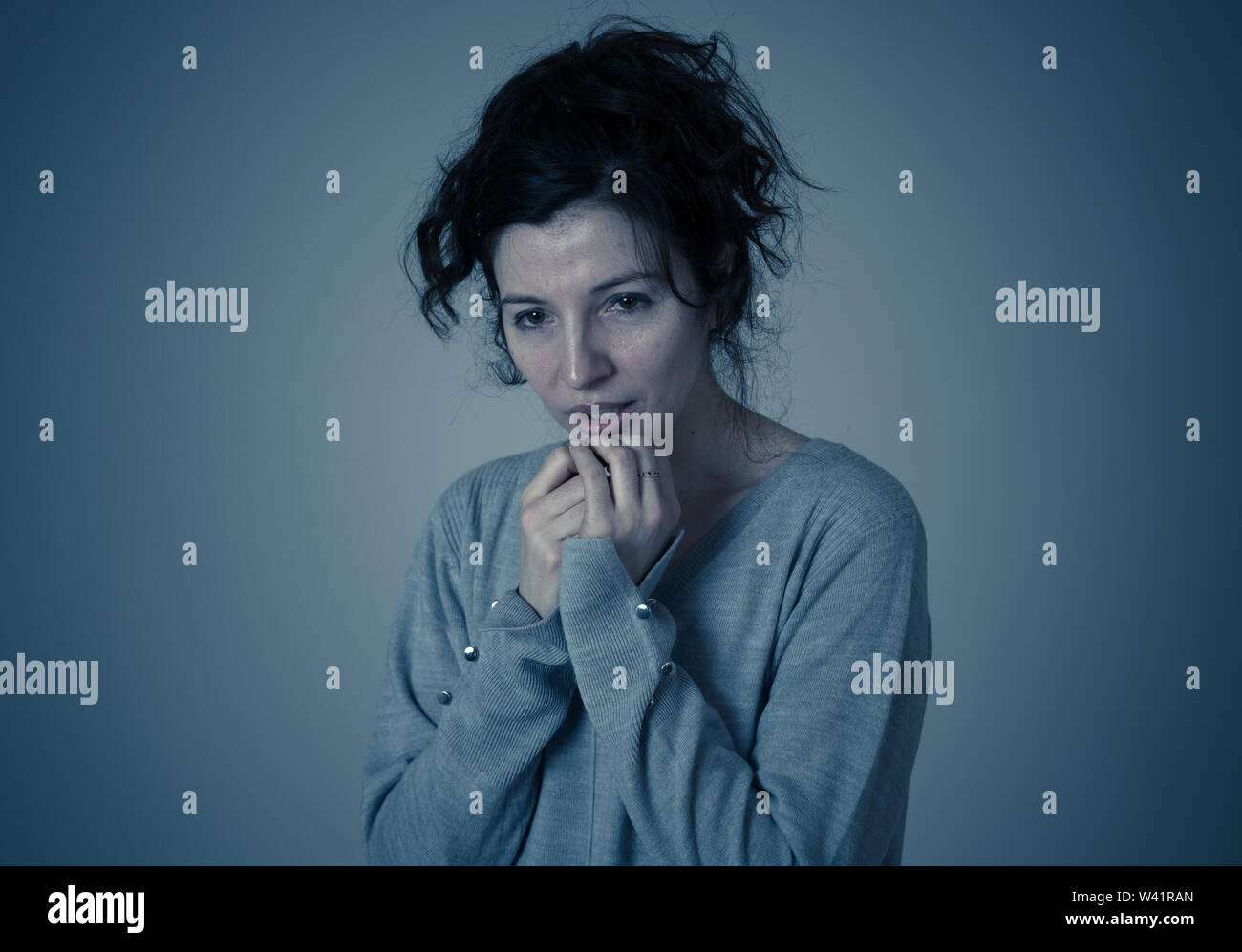 Close up of young scared and frightened woman, covering herself from ...