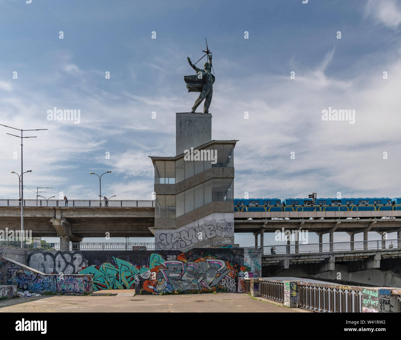 Two Soviet-era statues called the Young Pioneers stand on top of two ...