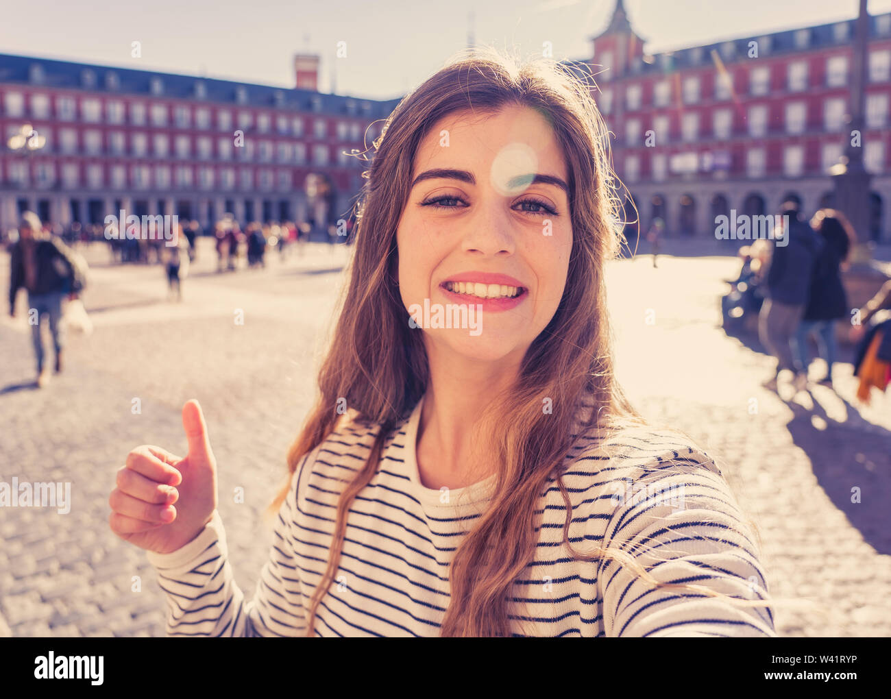 Beautiful young student tourist woman happy and excited in Plaza Mayor ...