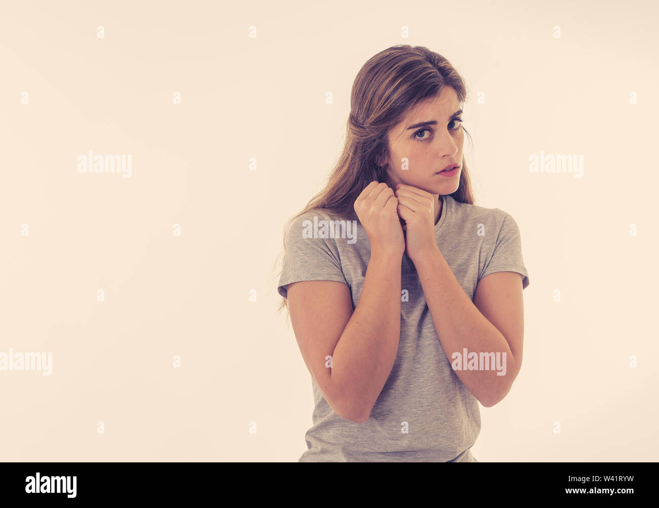 Portrait of young sad woman, scared and concerned, looking worried with ...