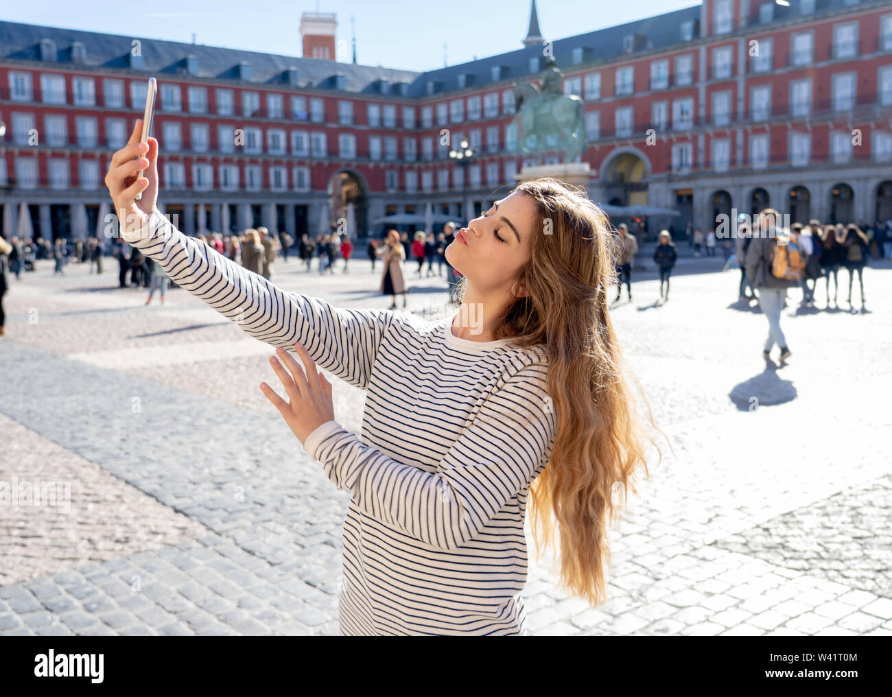 Beautiful young caucasian student tourist woman taking a selfie or ...