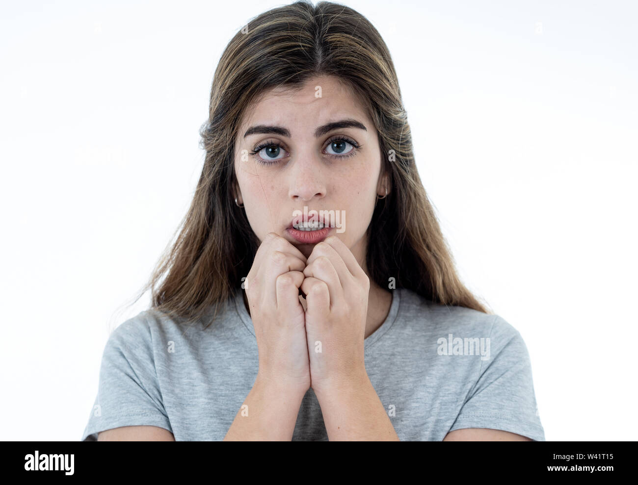 Young sad woman, serious and concerned, looking shocked and worried ...