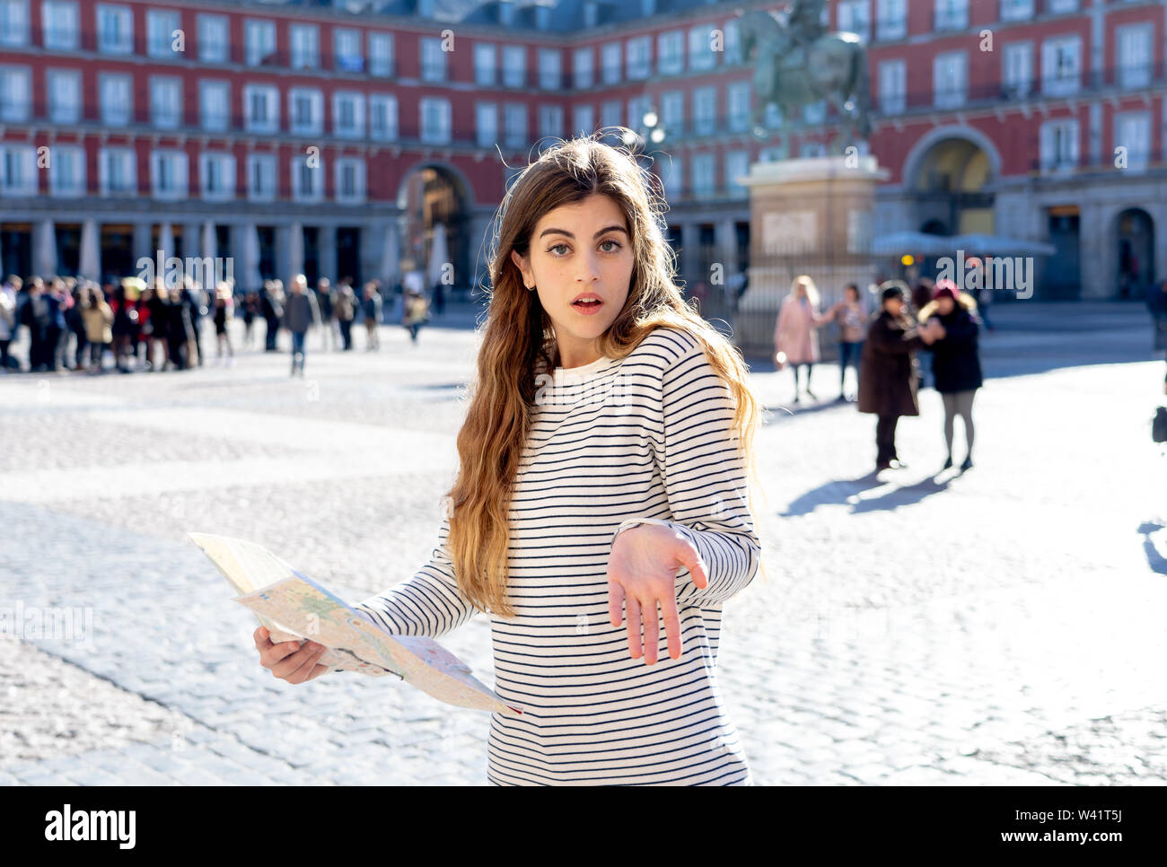 Lost young tourist trying to read a map for finding directions. Looking ...
