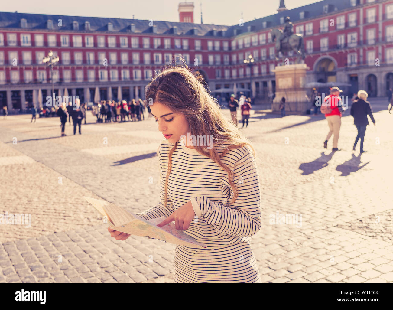 Lost young tourist trying to read a map for finding directions. Looking ...