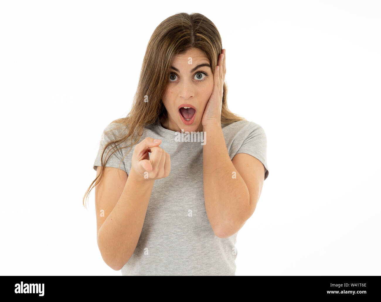 Beautiful young blond woman with happy face pointing and making ...