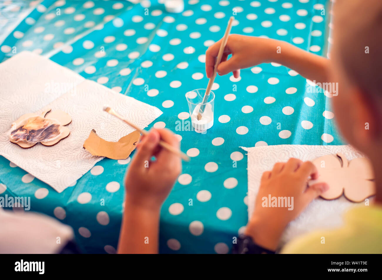 Children hands making artworks with wood and paint crafts. workplace ...