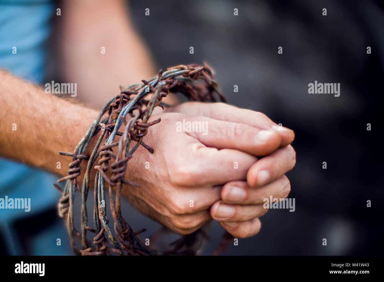 Prisoner hands barbed wire hi-res stock photography and images - Alamy