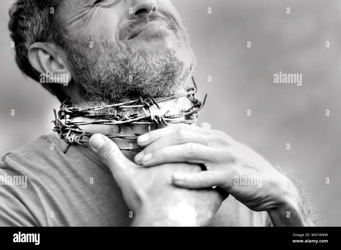 Man with barbed wire on the neck,having painful sore throat and ...