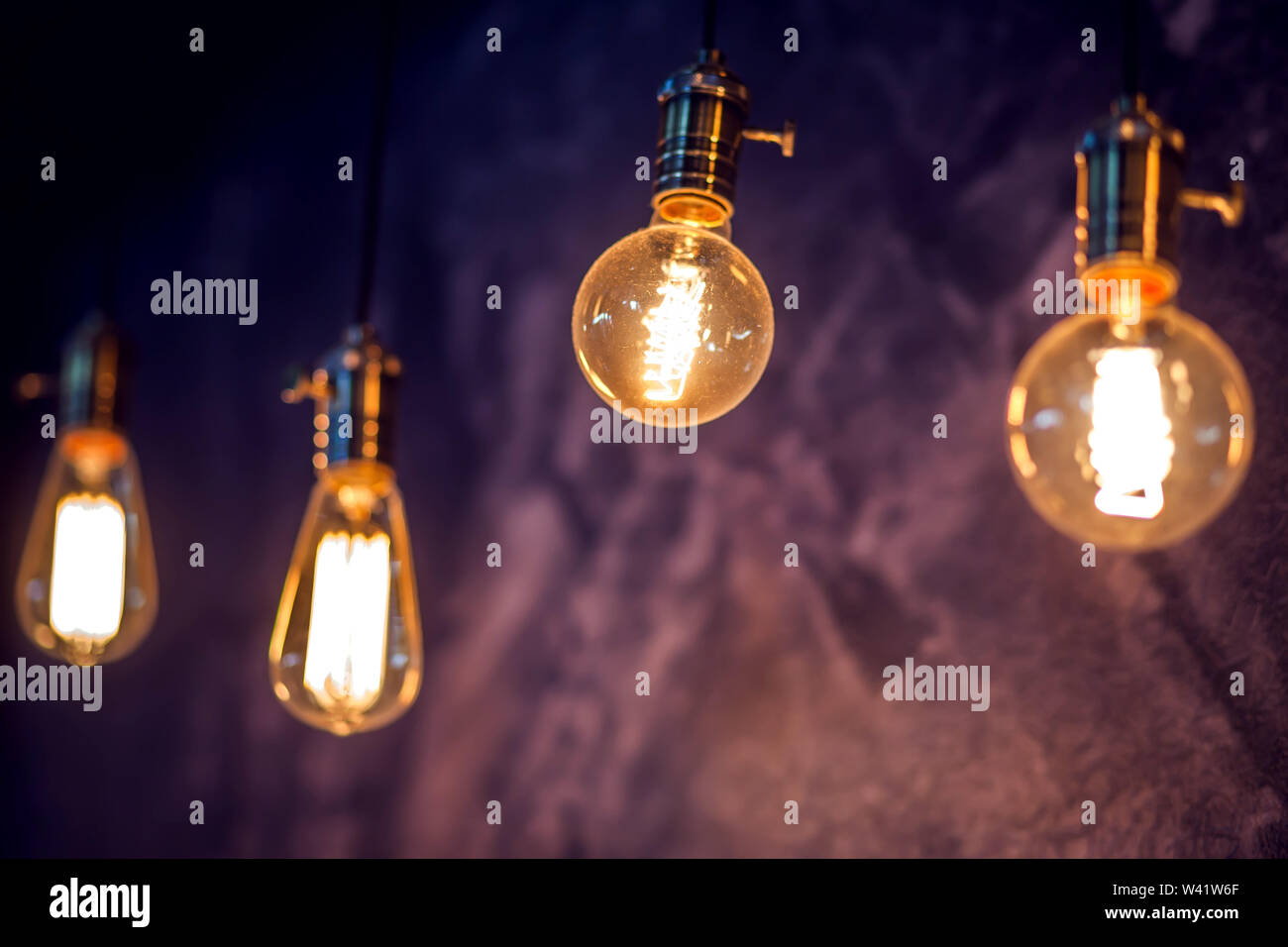 Vintage light bulb glowing in the dark Stock Photo - Alamy