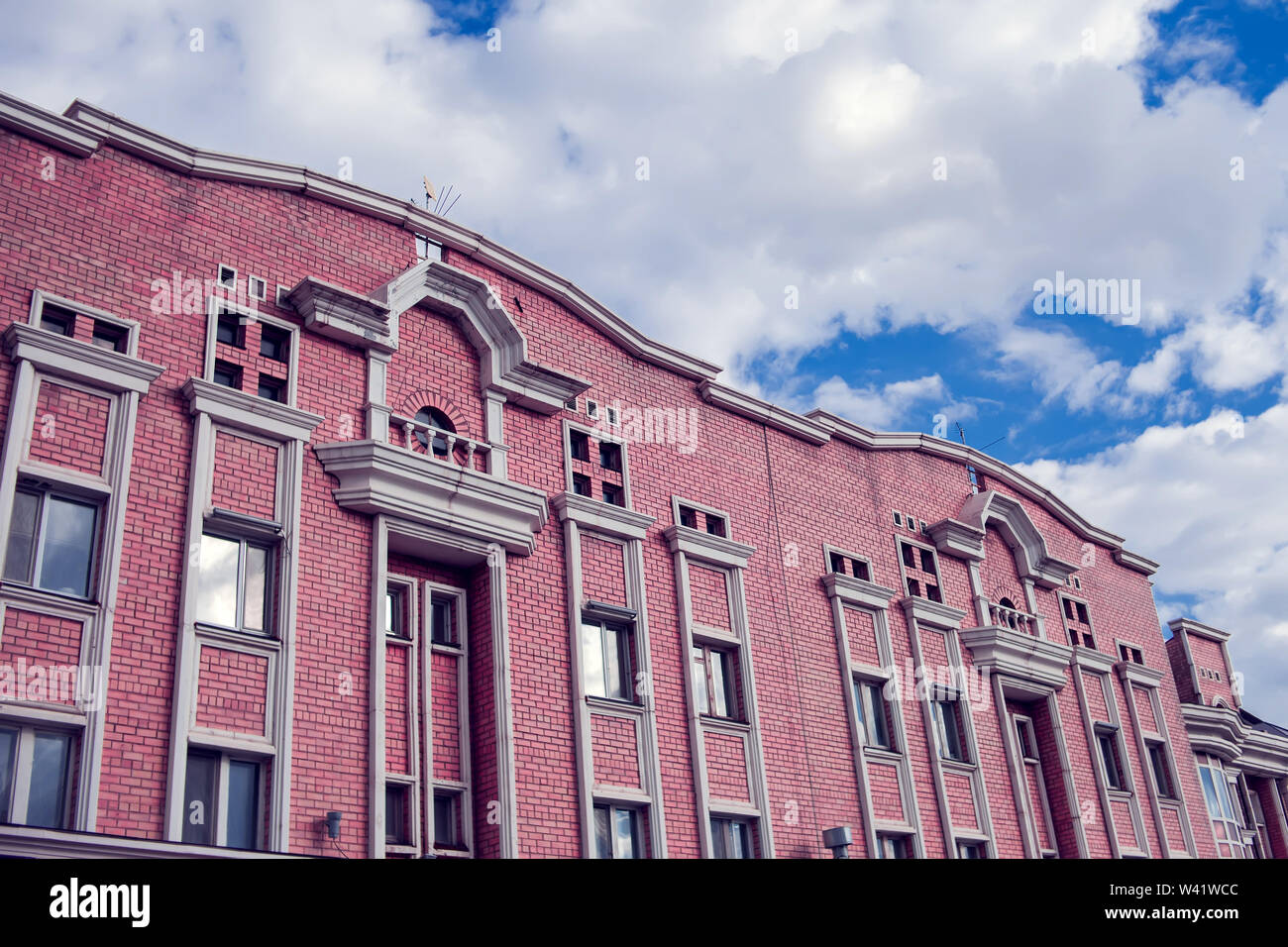 Red brick classic facade of the office building against blue sky Stock ...