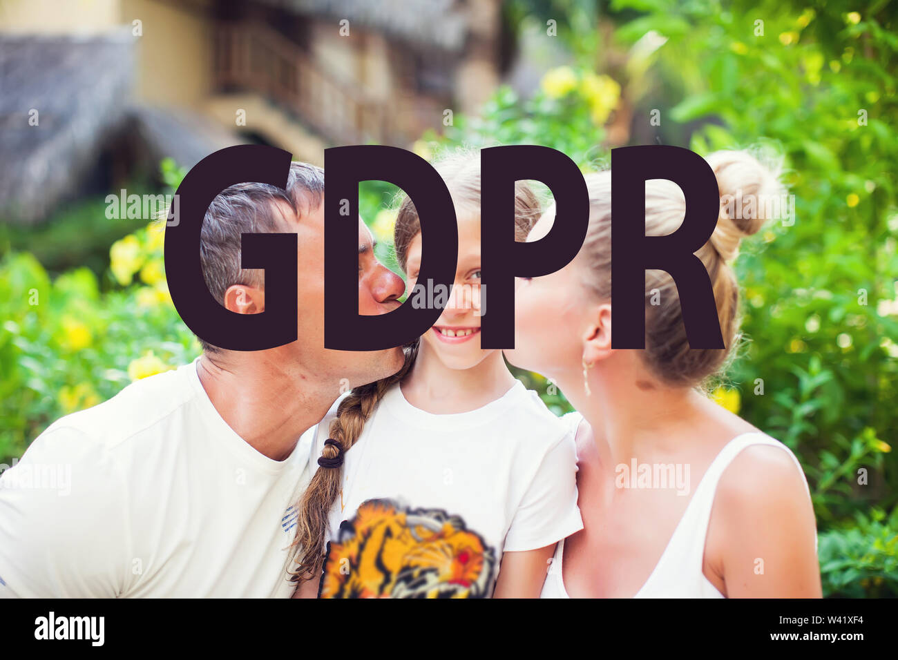 Mother and father kiss their child. GDPR - their face behind the ...