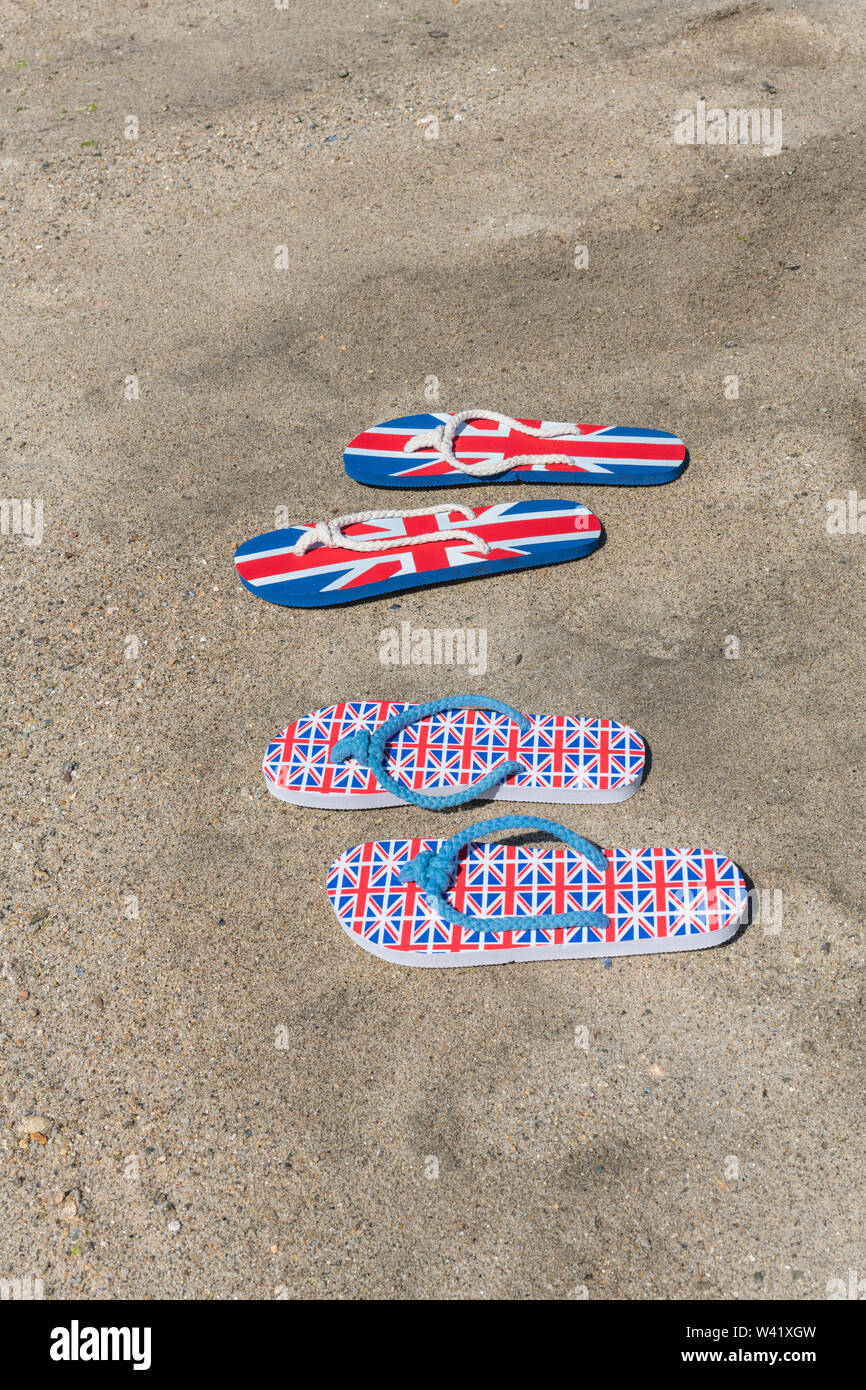 GB flag / Union Jack flip-flops on sandy beach - for 2021 UK staycation ...