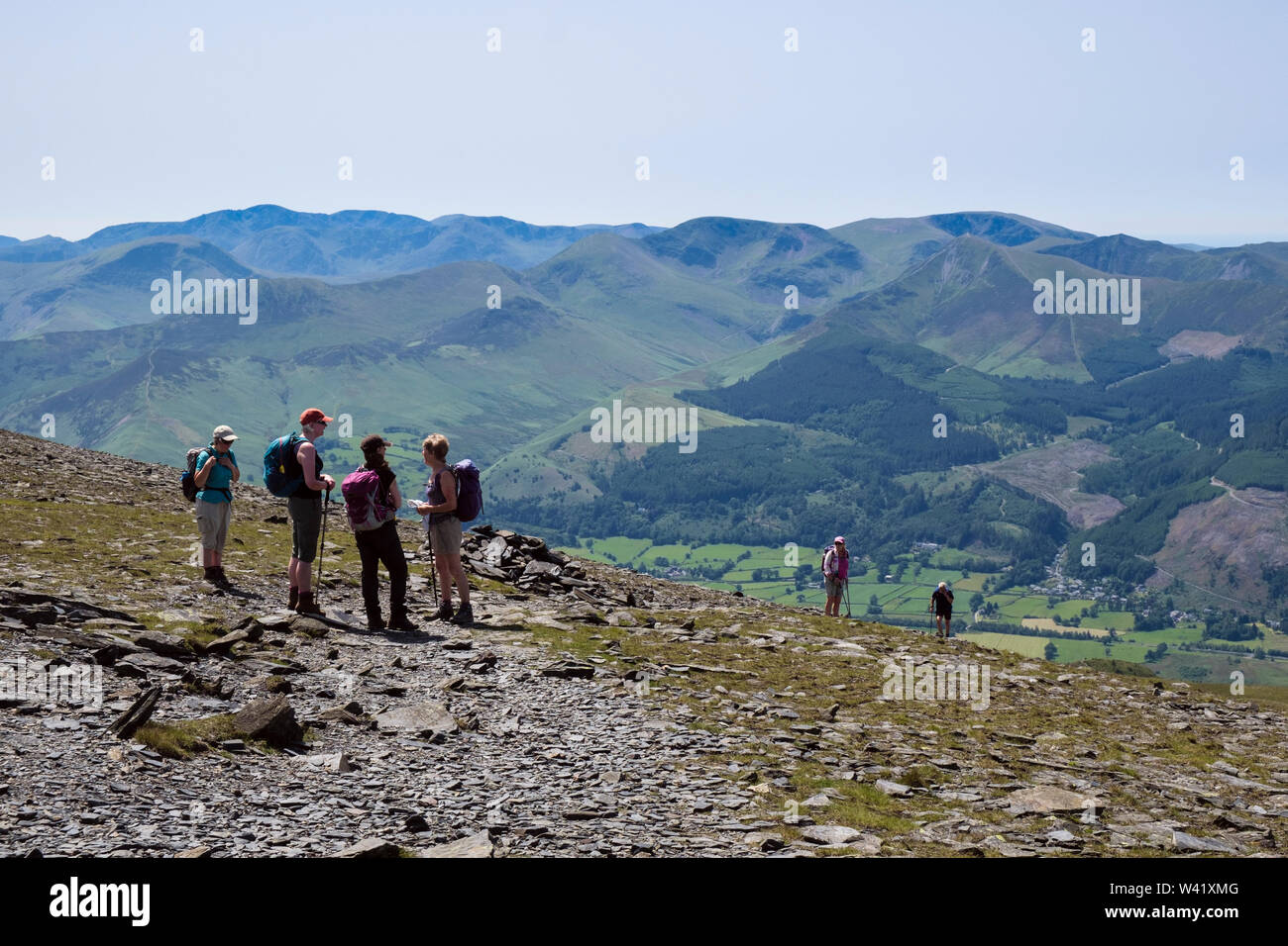 Hikers hiking up Skiddaw mountain path above Braithwaite in Lake ...