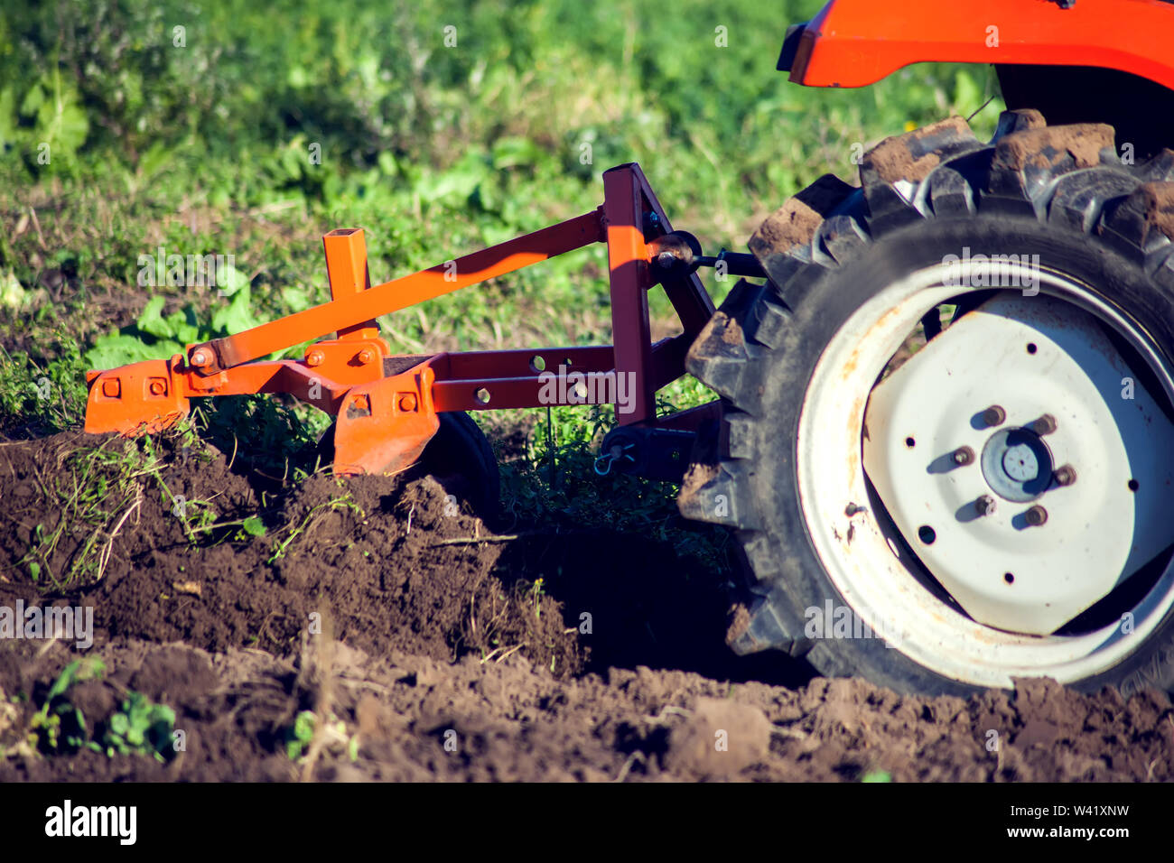 Tractor plowing fields -preparing land for sowing. Agricultural work in ...