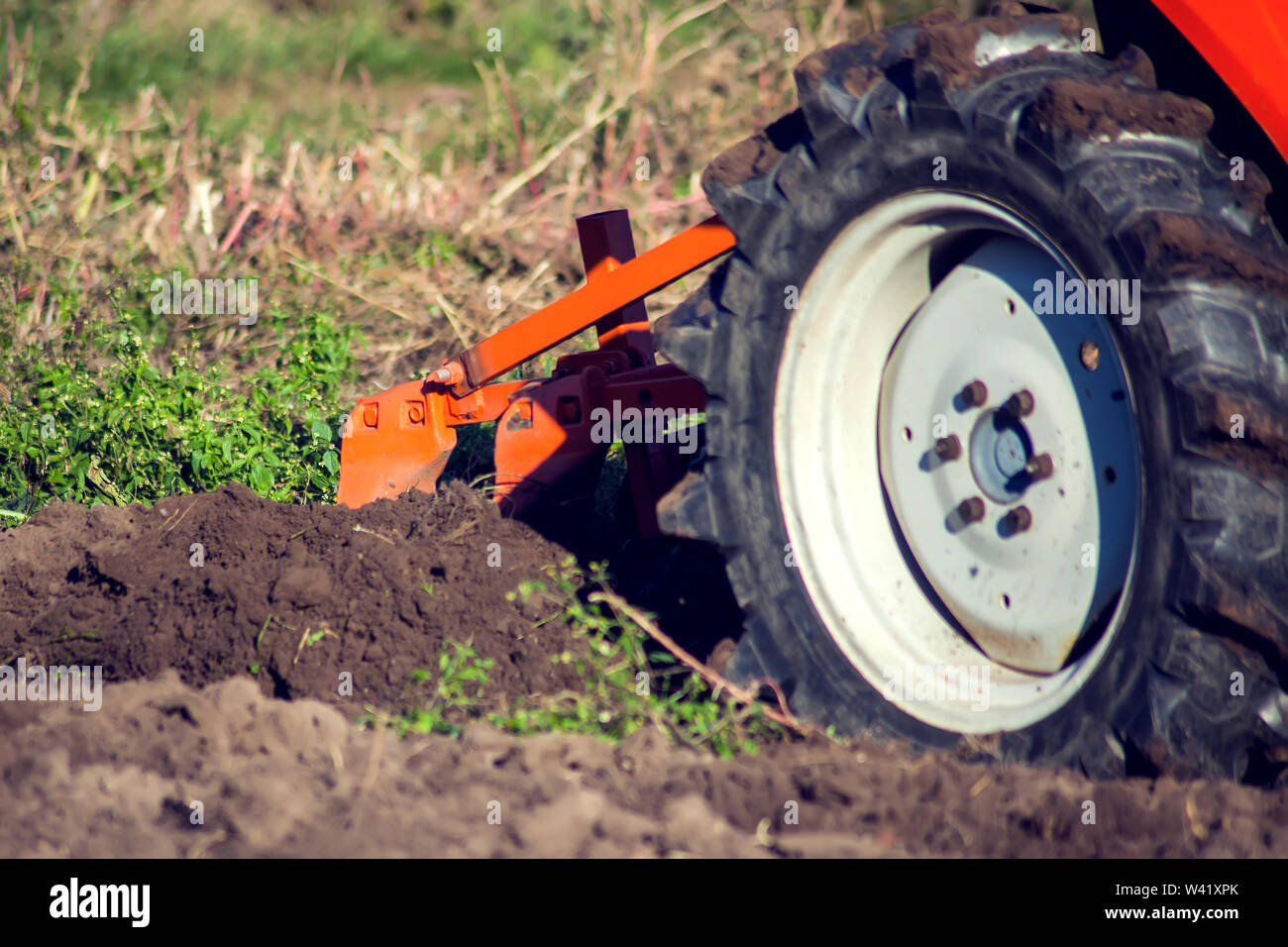Tractor plowing fields -preparing land for sowing. Agricultural work in ...