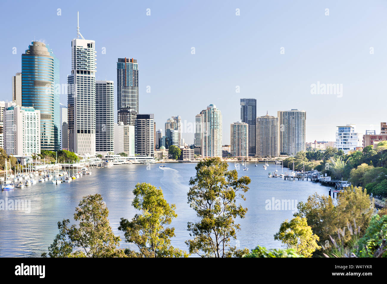 Brisbane City tall buildings under the blue sky with blue water river ...
