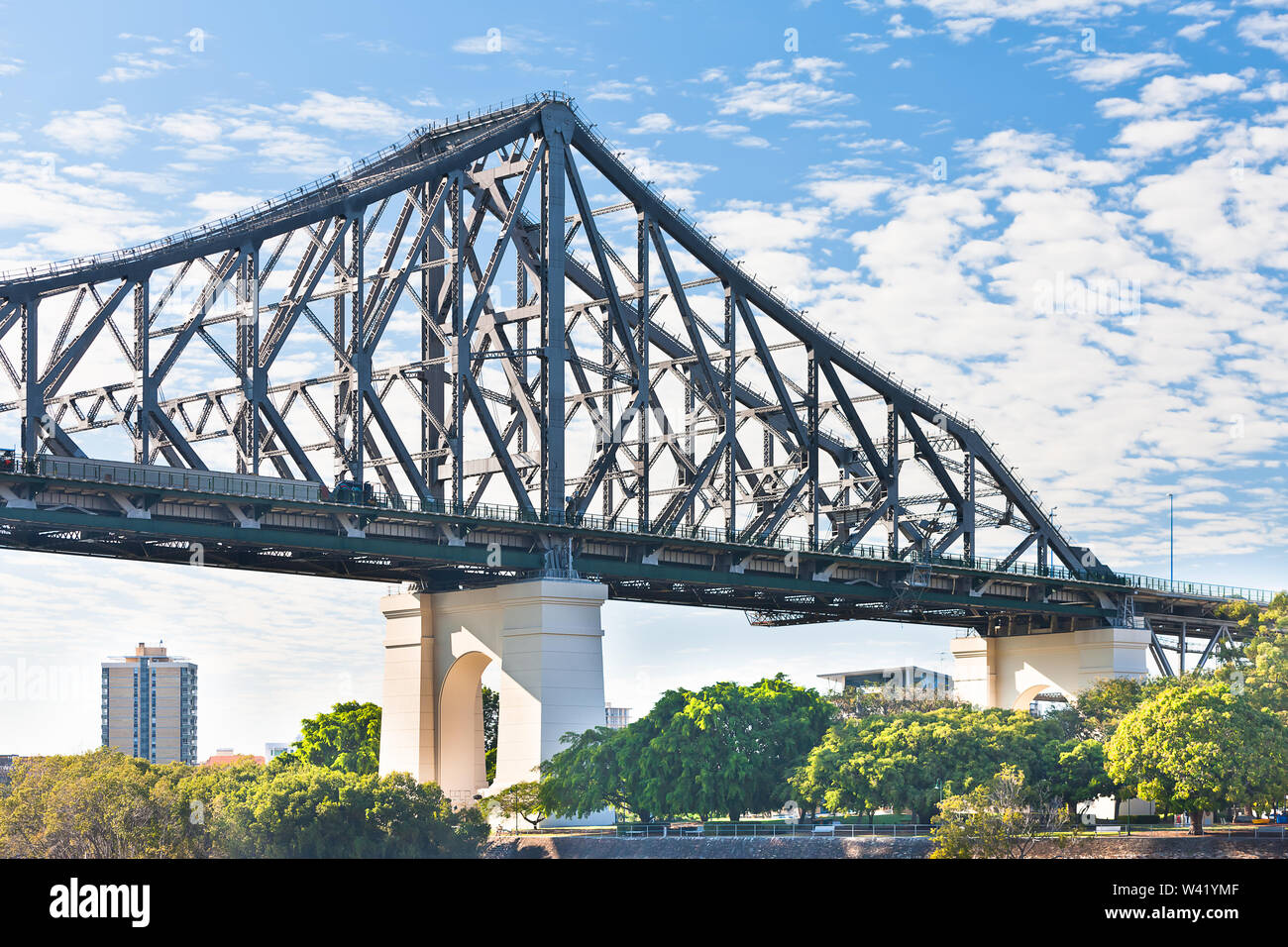 Huge metal bridge holding by big concrete pillars over the river and ...