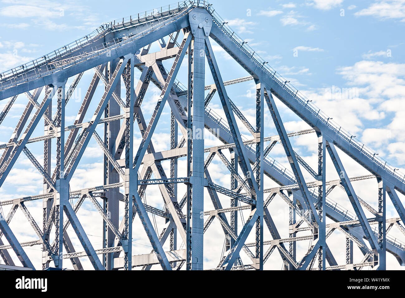 Closeup and top of a huge metal bridge showing steel beams and pillars ...