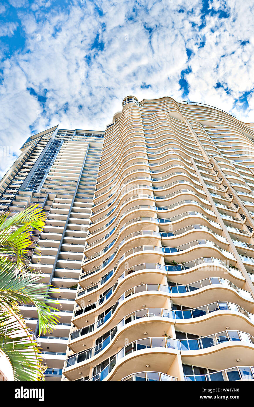 Low angle view of a modern and a tall building with white clouds from a ...