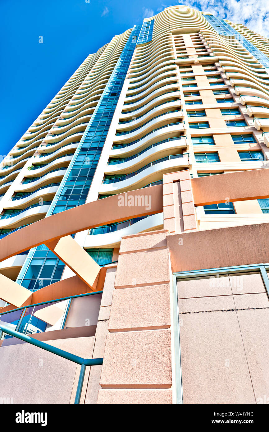 Low angle of a huge and tall business building with blue sky showed ...