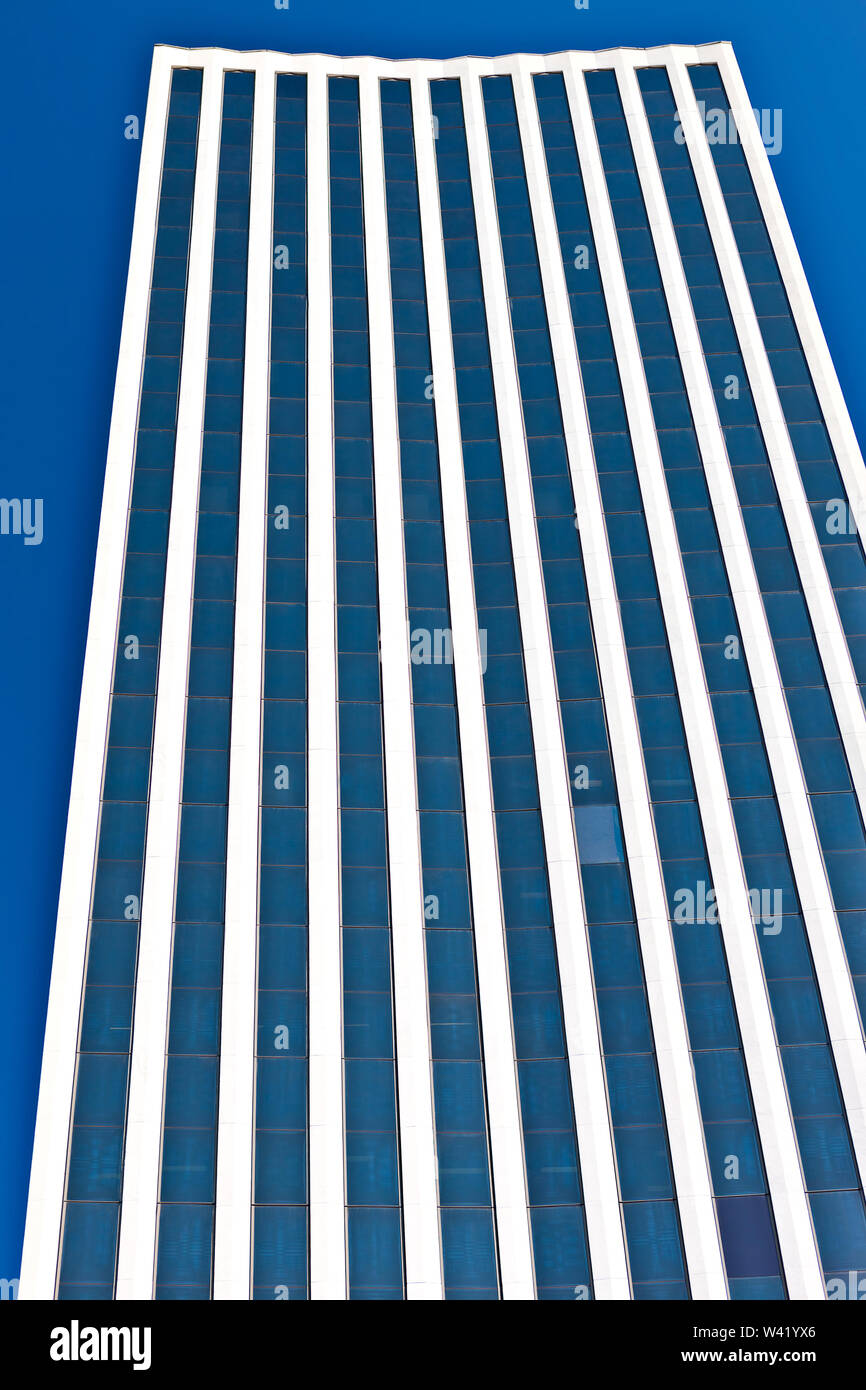 Dark blue windows with white lines of a modern building with the dark ...