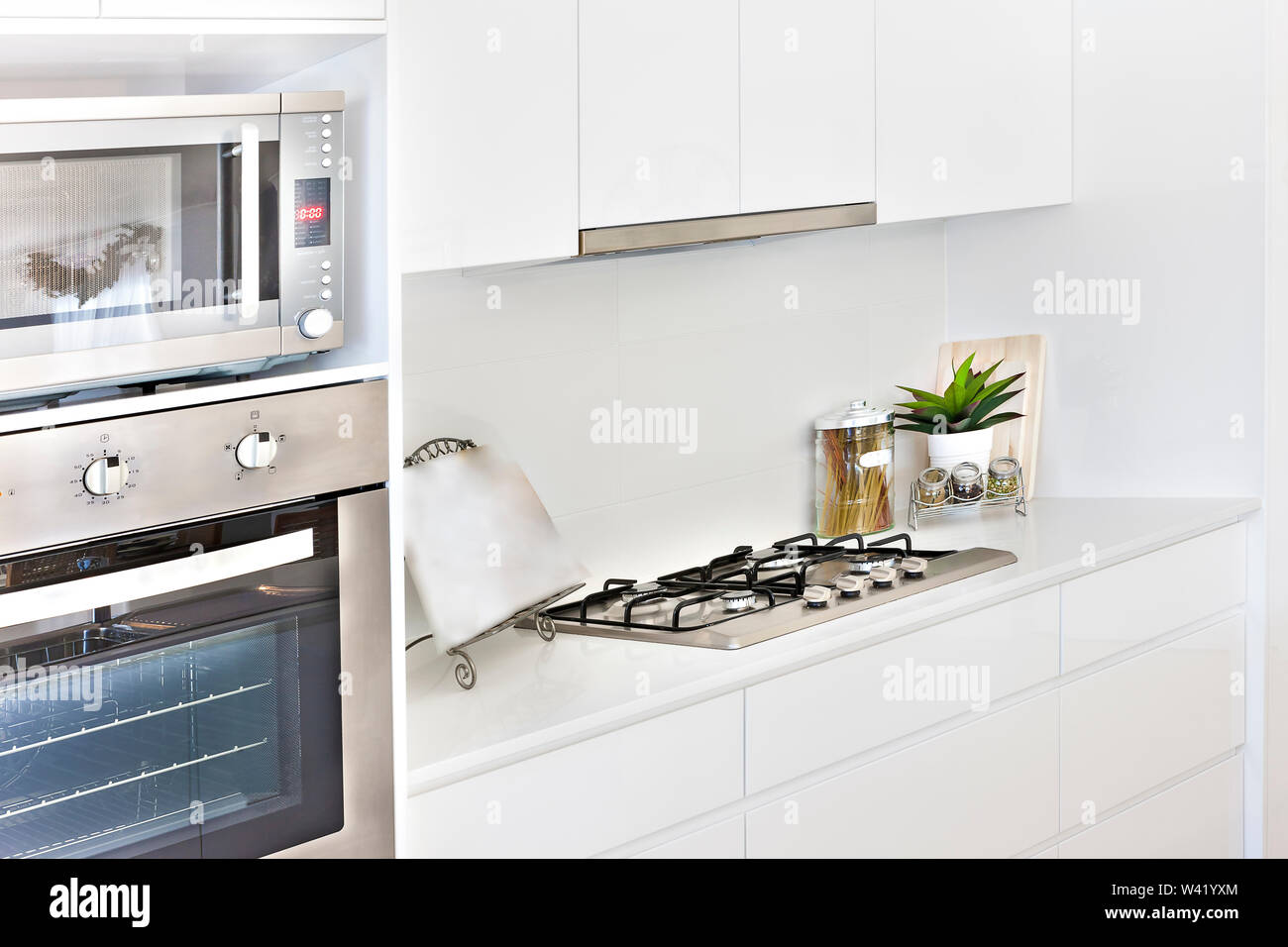Modern Kitchen tools with white walls and oven, gas cooker also some ...