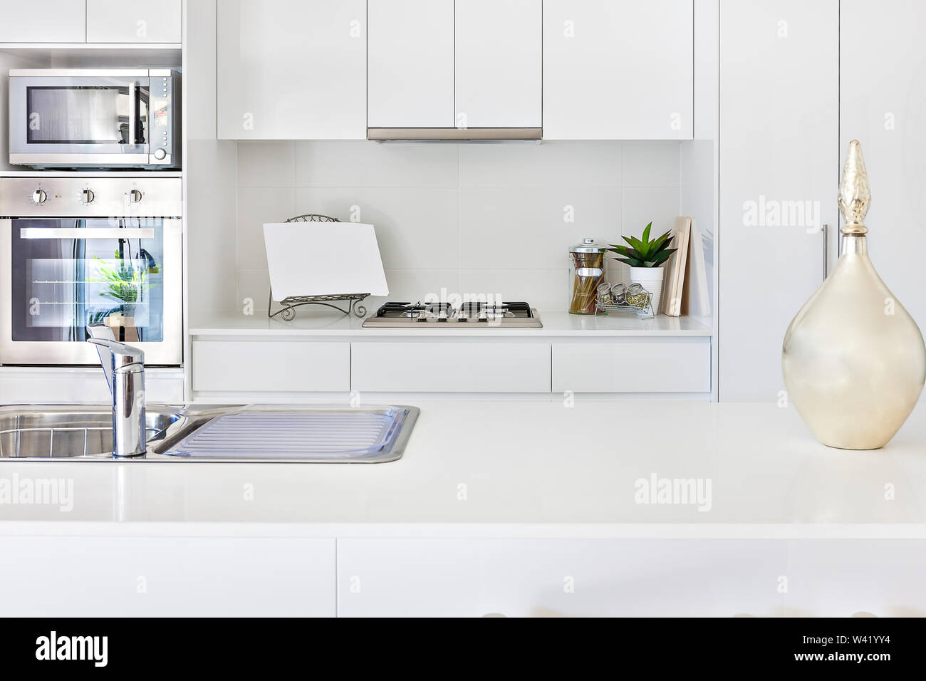 Luxurious Kitchen tools with white walls and oven, , evening time at ...