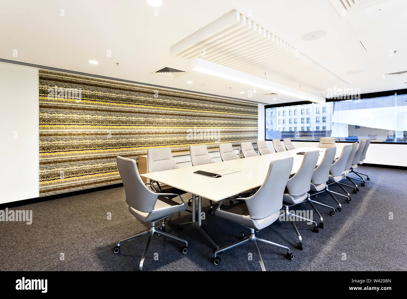 Conference room with chairs and large office window under flashing ...